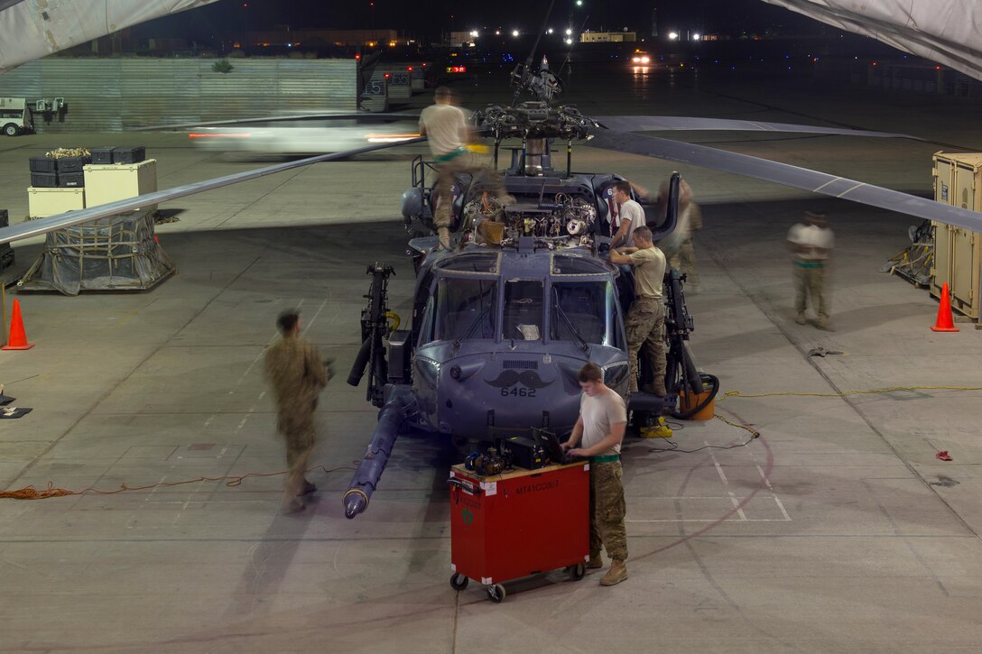 U.S. airmen work to complete a 50-hour inspection of an HH-60 Pave Hawk ...