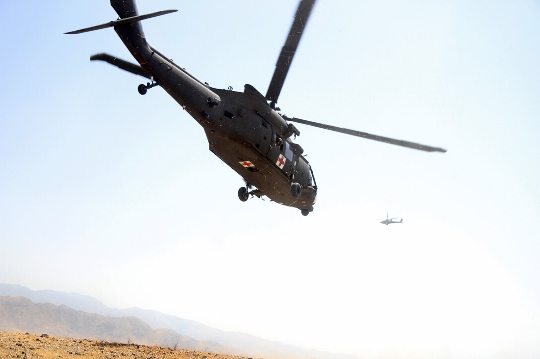 A UH-60 Black Hawk medevac helicopter lifts off with a simulated ...