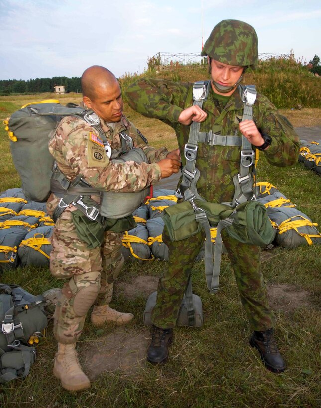 U.S. Army Sgt. 1st Class Angel Nicanor, left, assists Lithuanian Land ...