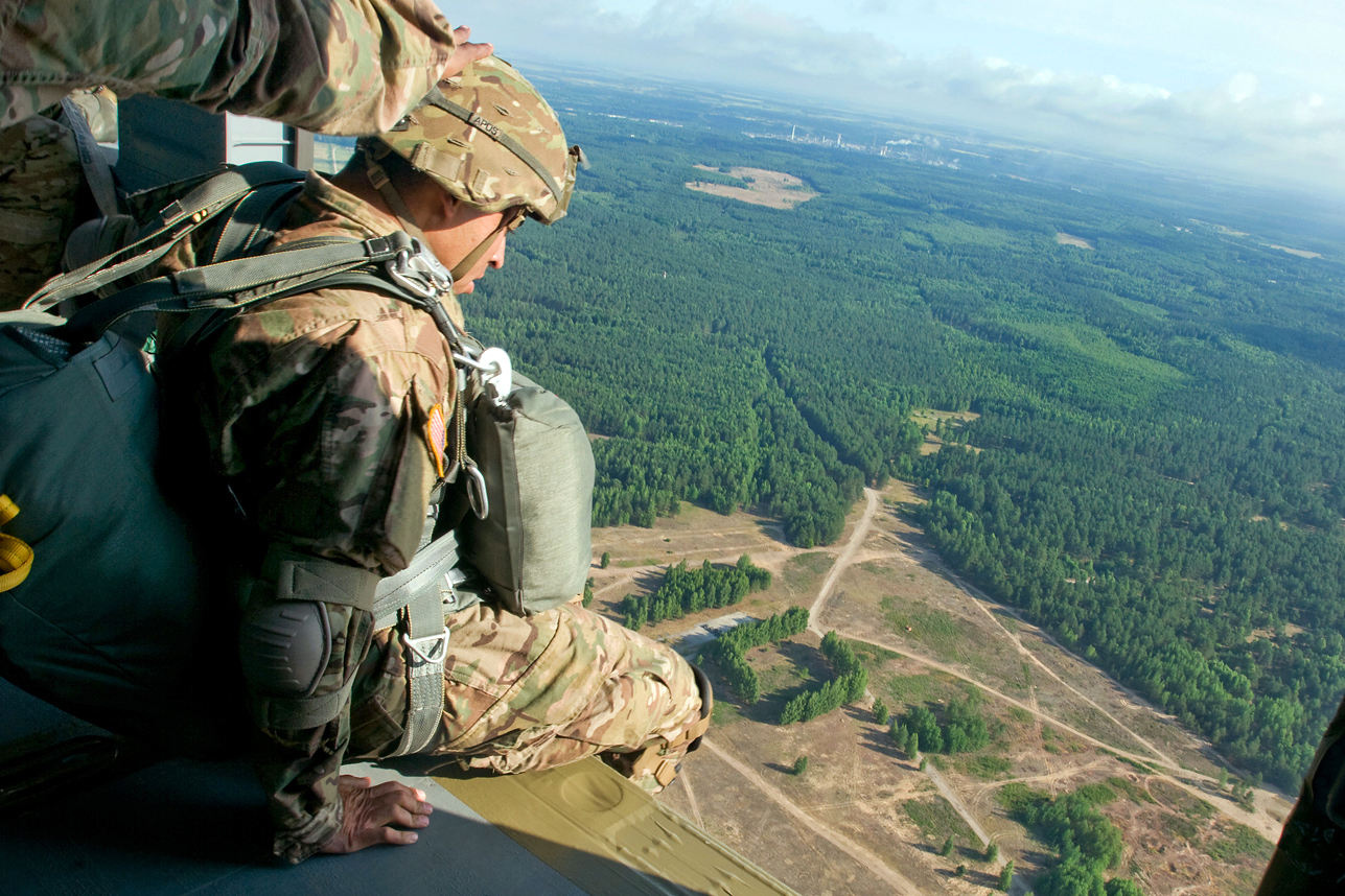 A U.S. paratrooper jumps from a UH-60M Black Hawk helicopter near Rukla ...