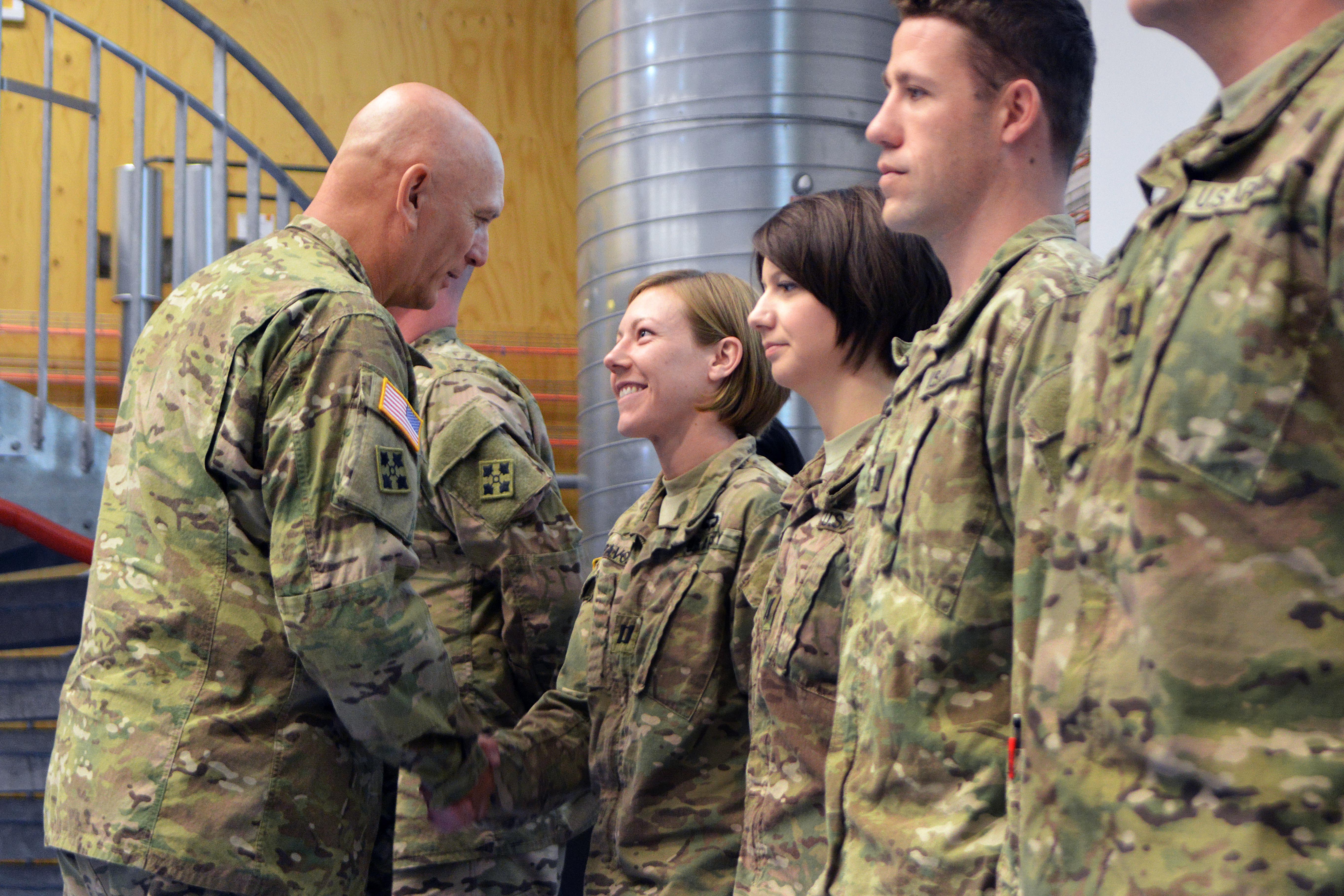 U.S. Army Chief of Staff Gen. Ray Odierno, left, presents coins to ...
