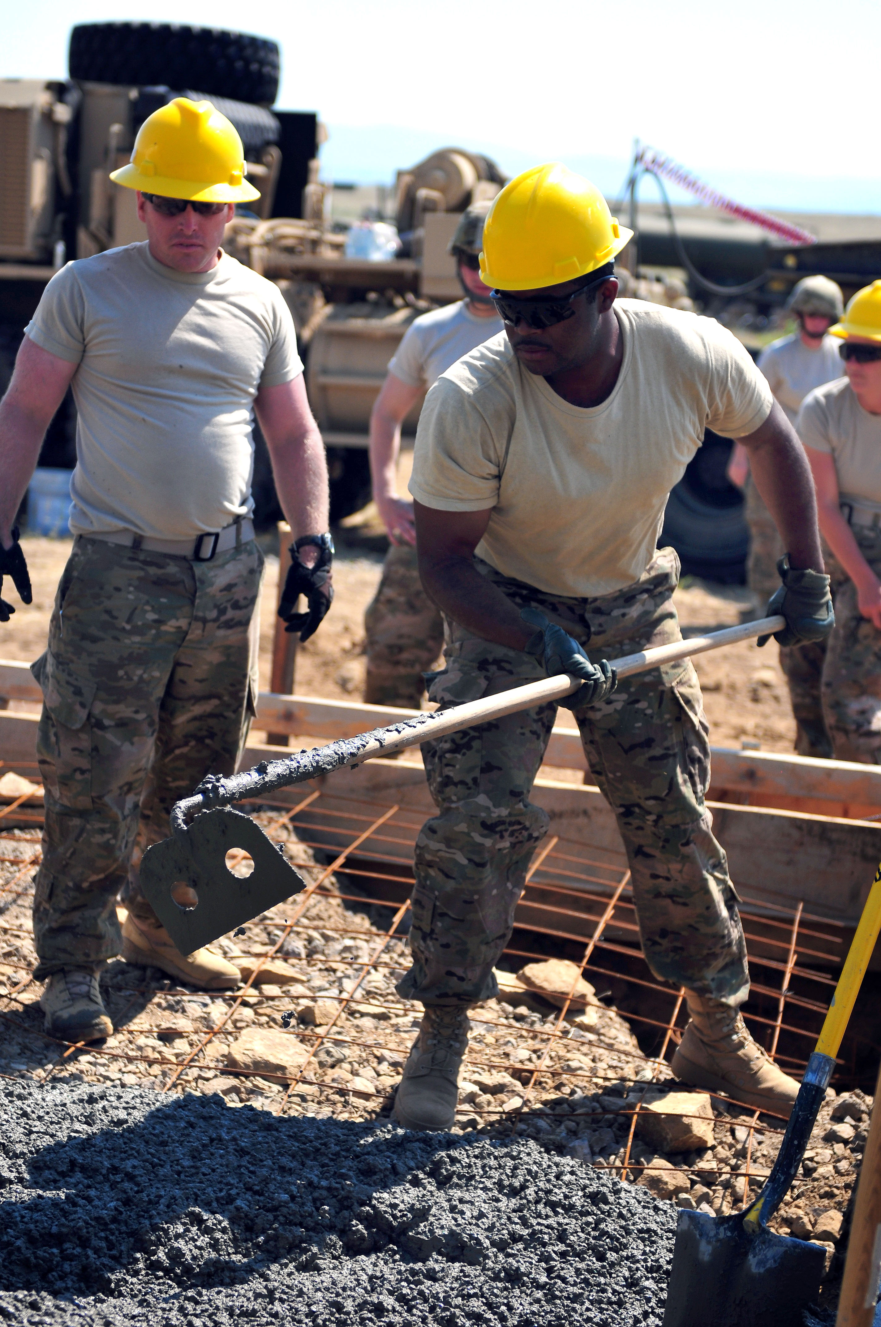 U.S. Army Spc. Shawn Young smooths concrete for one of many buildings ...