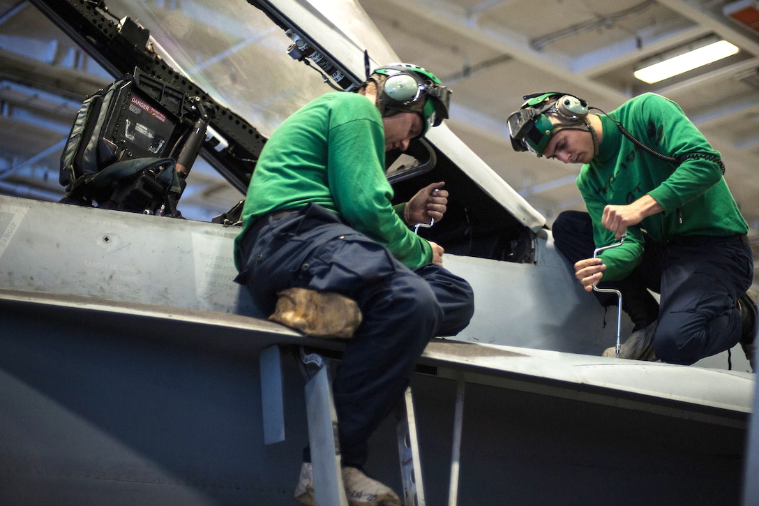 U.S. Navy Petty Officer 2nd Class Christopher Bartel and U.S. Navy ...