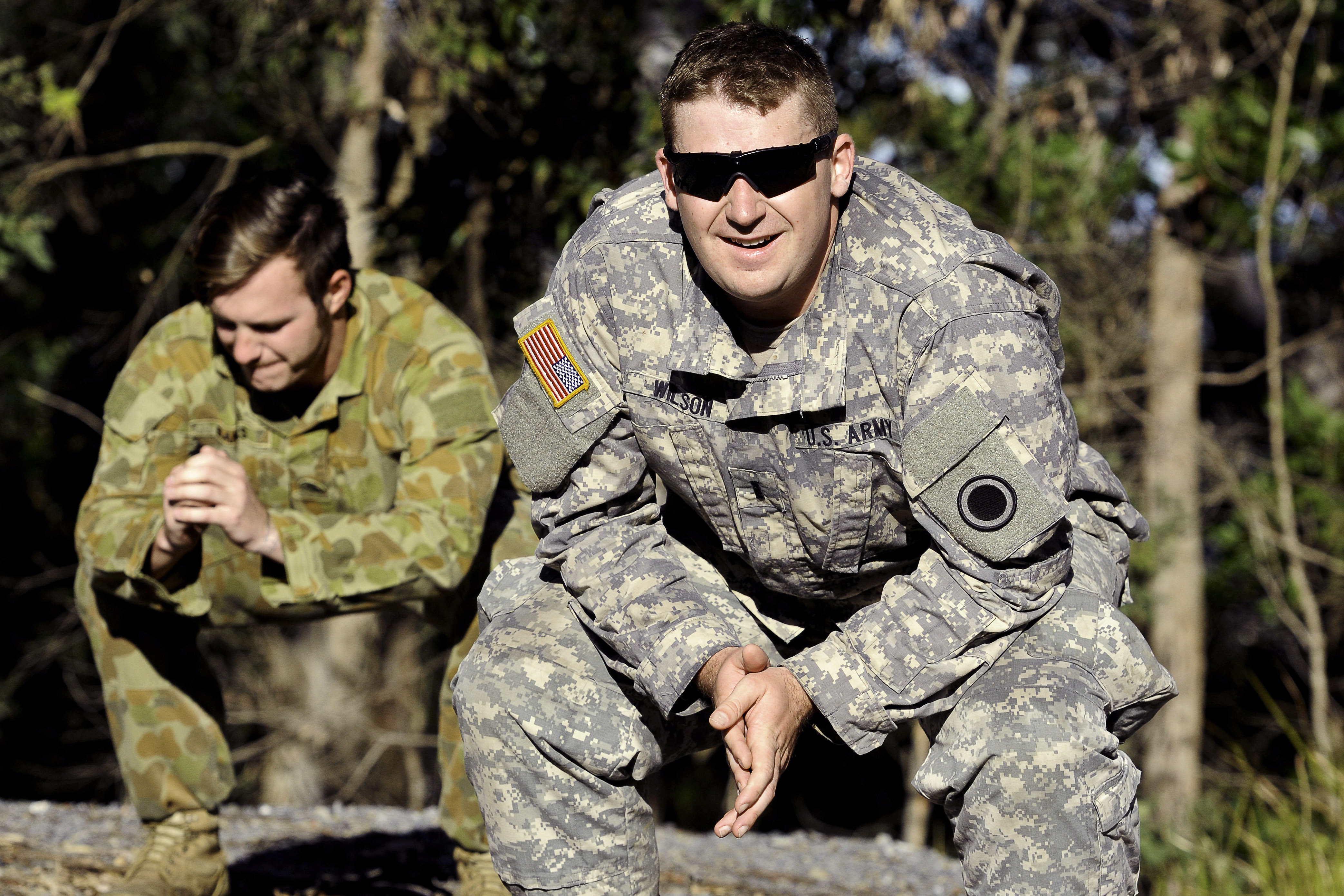 U.S. Army 1st Lt. Joshua Wilson, right, conducts the "Sally" workout ...