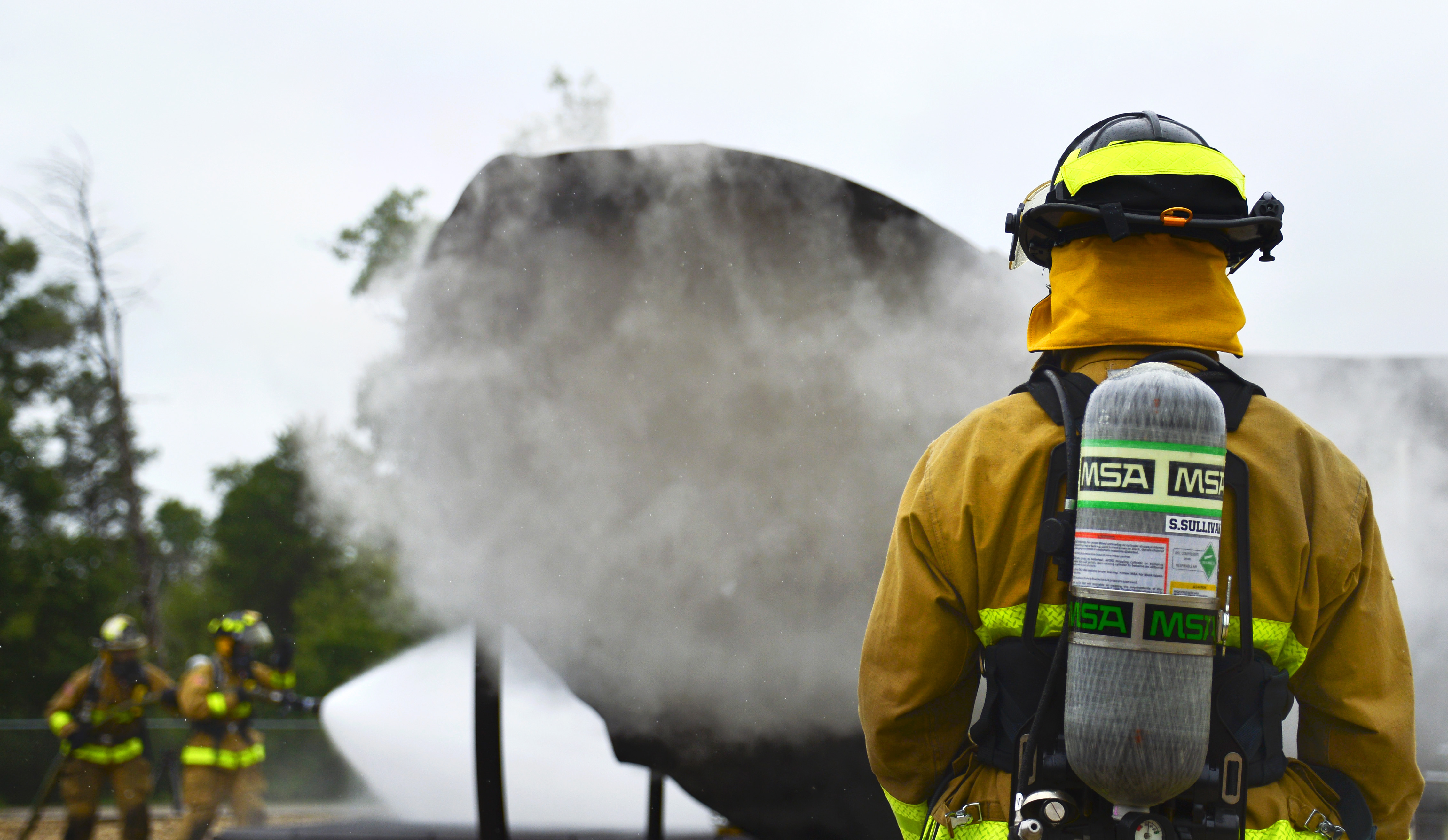 Firefighters spray water during an aircraft rescue and fire burn to ...