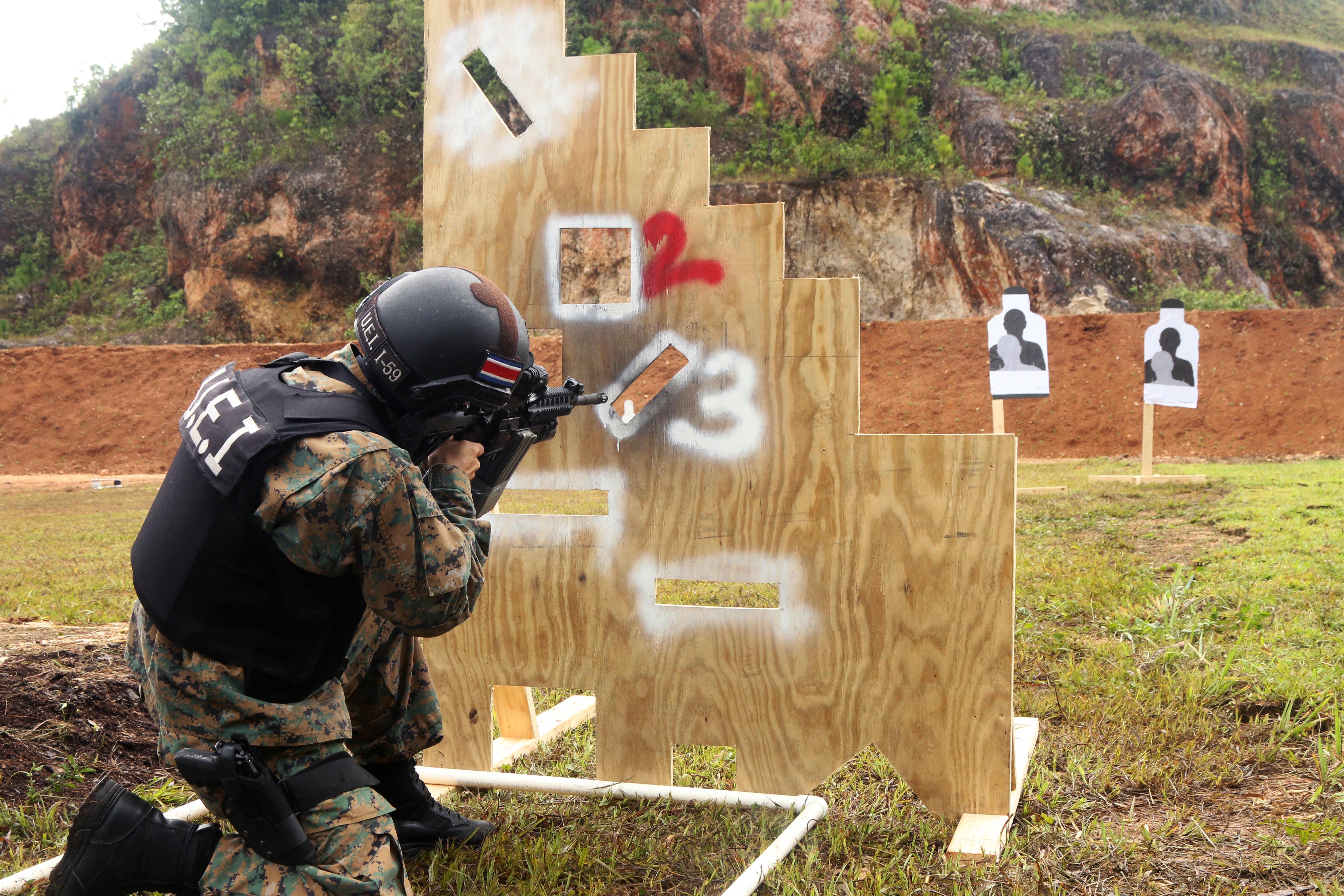 A Costa Rican special intervention unit member fires his weapon on the ...