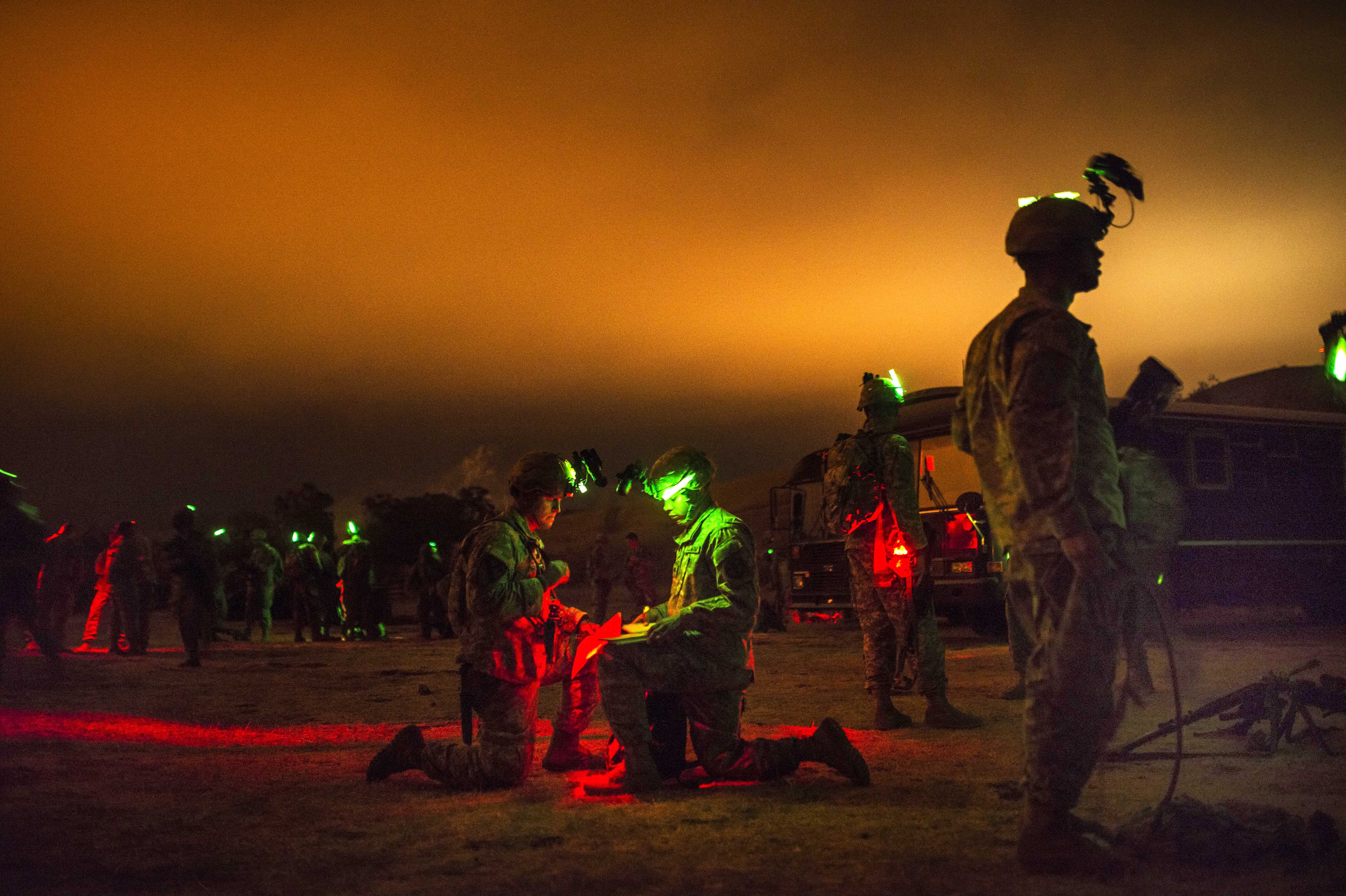Army reservists review map before participating in a night land ...