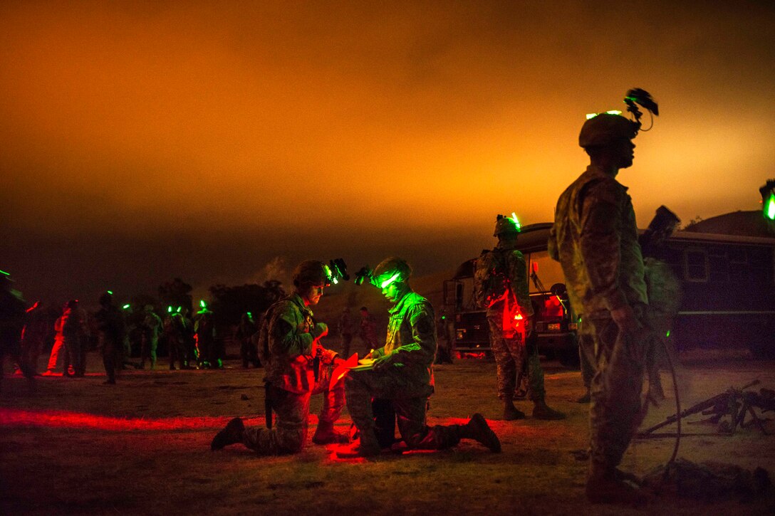 Army reservists review map before participating in a night land ...