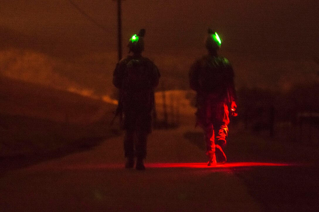 Army Reserve Cpls. Brock O'Shaughnessy and James Farran walk along a ...