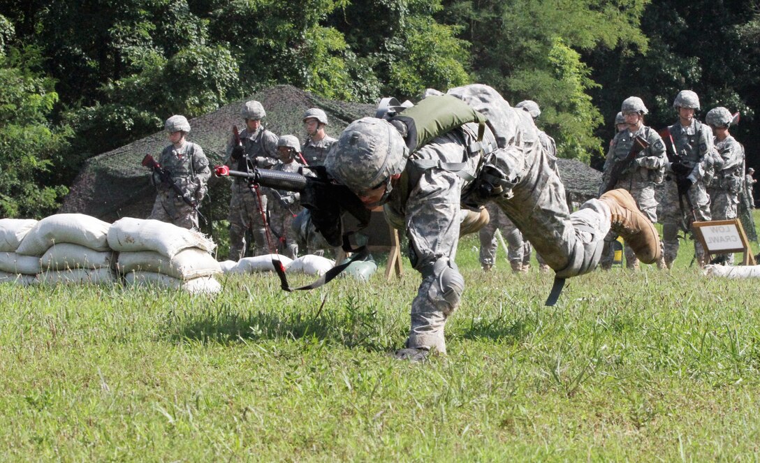 AN Army cadet dives into position before beginning the high-crawl ...