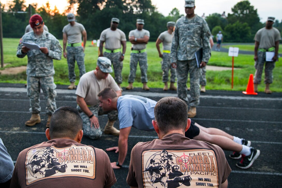 Soldiers provide guidance and instructions on how to properly perform a ...