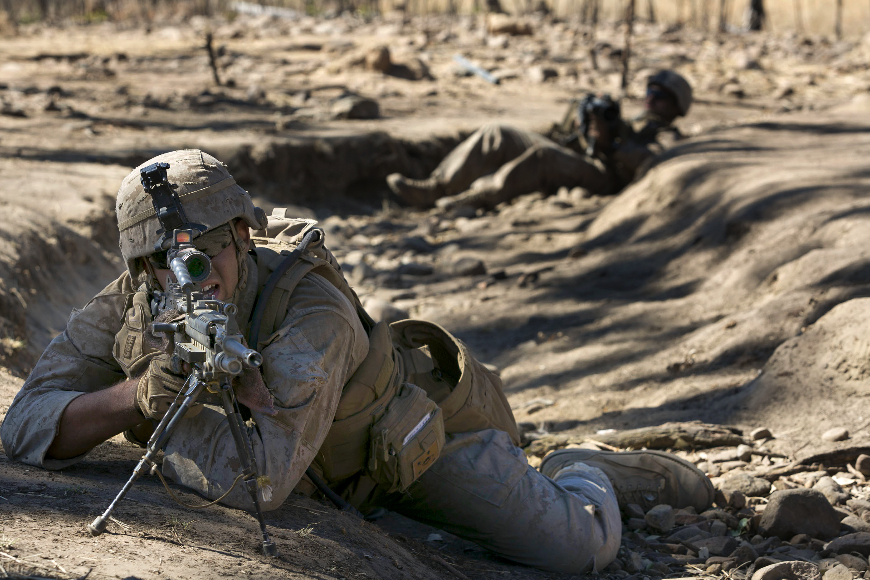 U.S. Marine Corps Lance Cpl. Darel Williams suppresses the enemy during ...