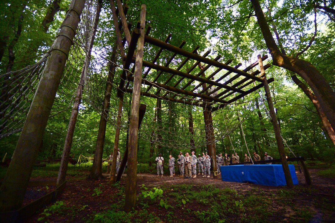 Members from Army, Navy and Air Force Combat Camera teams observe a ...
