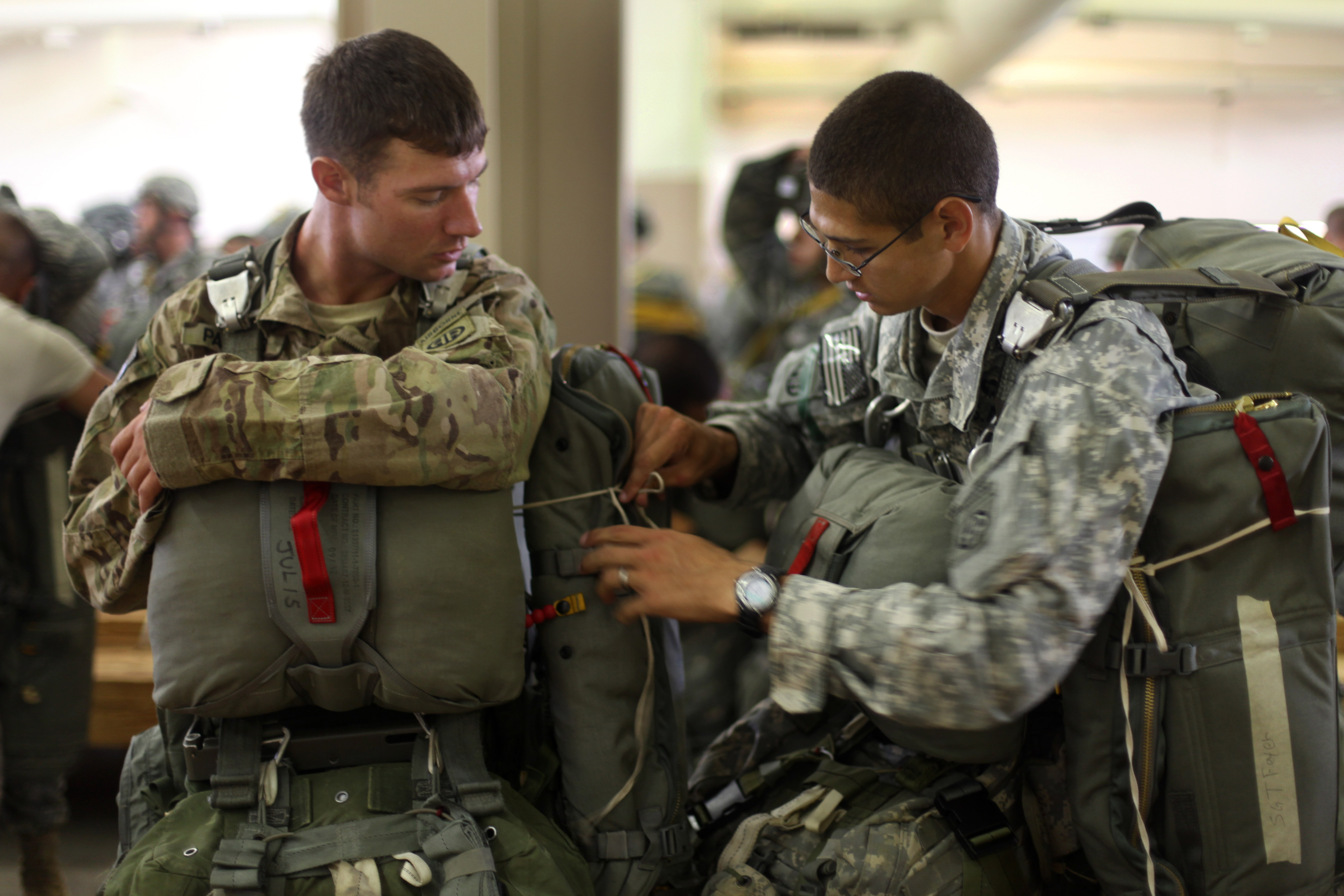 Army Sgt. Zachary Feyer, right, assists Army Staff Sgt. Christopher ...
