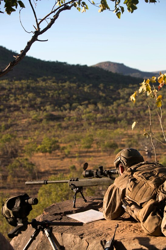 U.S. Marine Lance Cpl. Austin Warren engages simulated targets with an M40A1 sniper rifle from ...