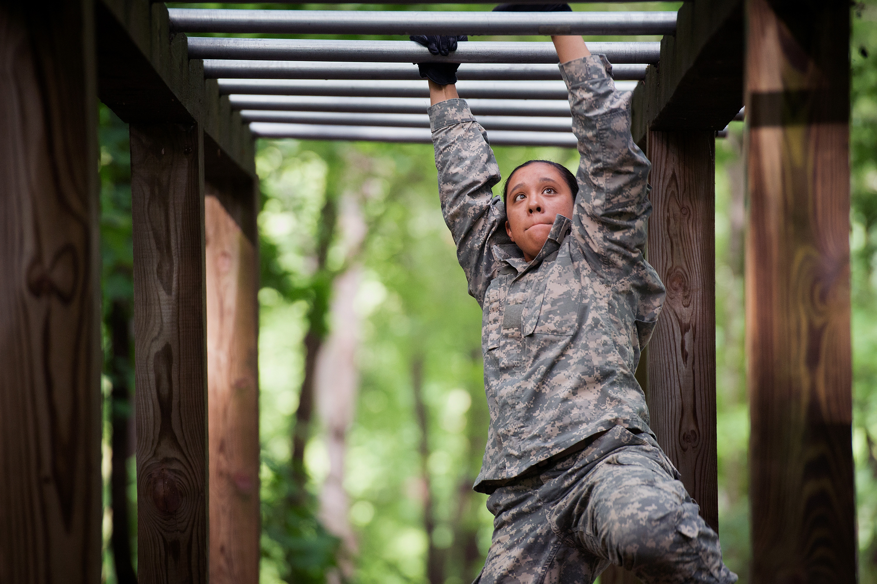 Army Pvt. Noel Toye traverses across the “Tarzan” obstacle during the ...