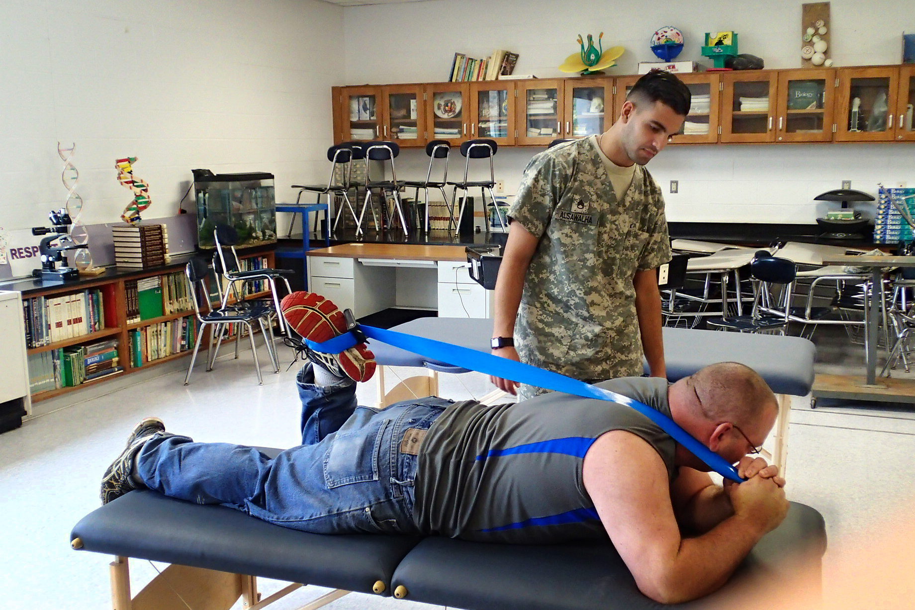 Army Staff Sgt. Musab Alsawalha instructs a patient on proper ...