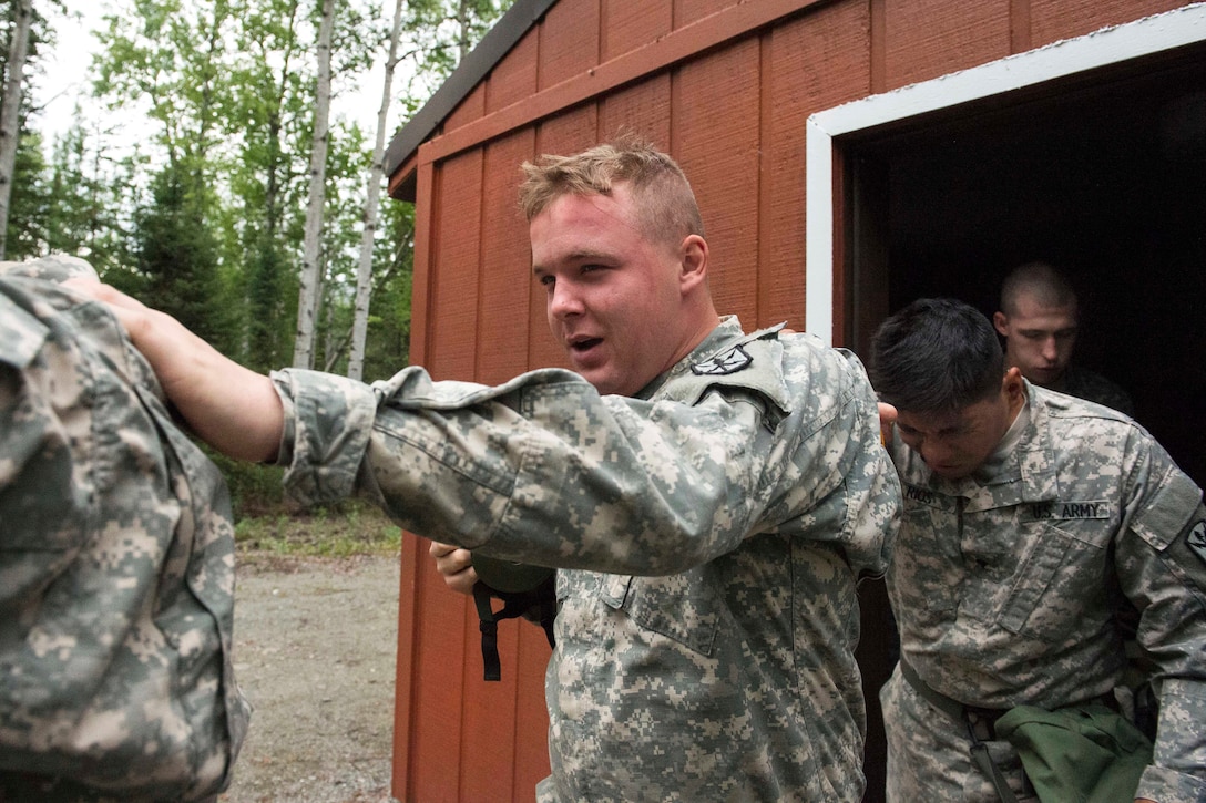 Soldiers exit the gas chamber during chemical, biological, radiological ...
