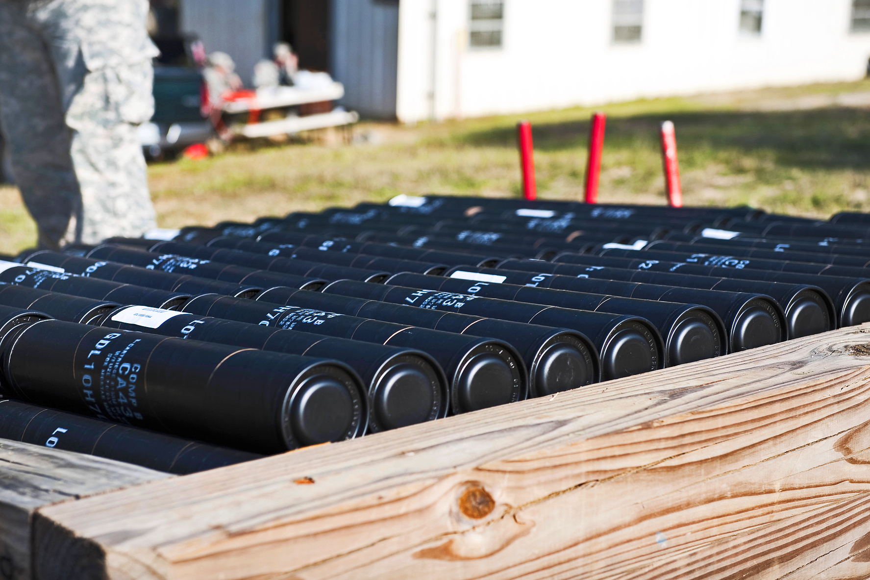 81-mm mortar rounds, still in their shipping tubes, pictured before a ...