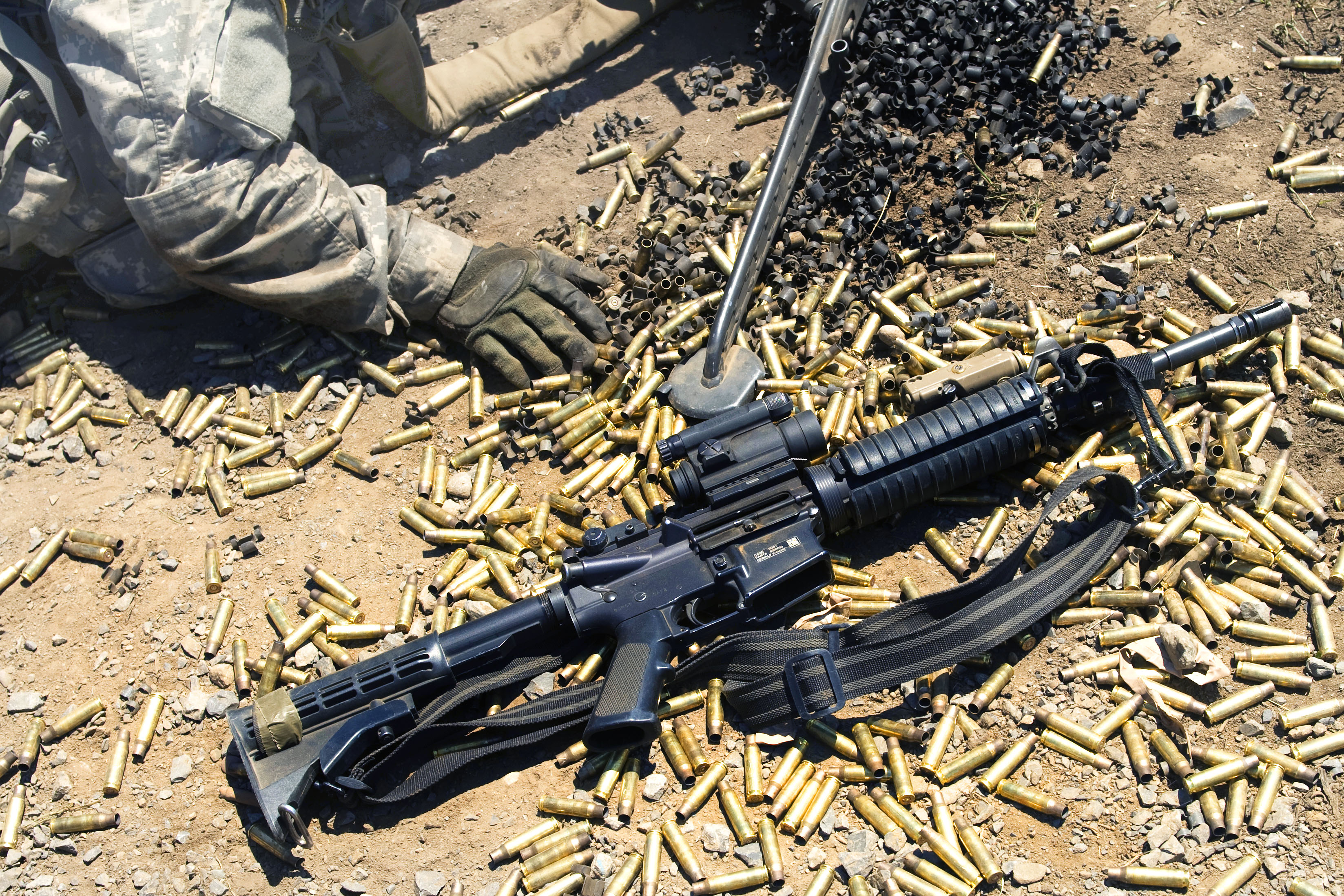 Fired shell casings lay around an M16 rifle after a live-fire exercise ...