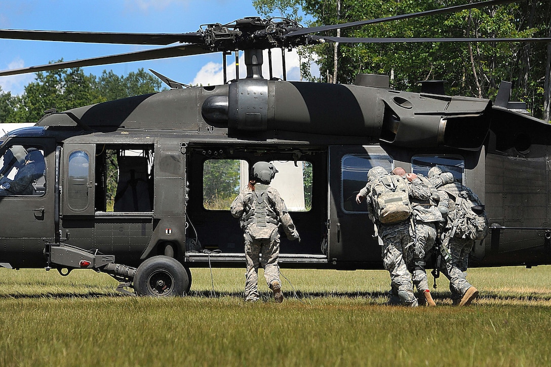 Soldiers load a simulated casualty onto a UH-60 Black Hawk medical ...