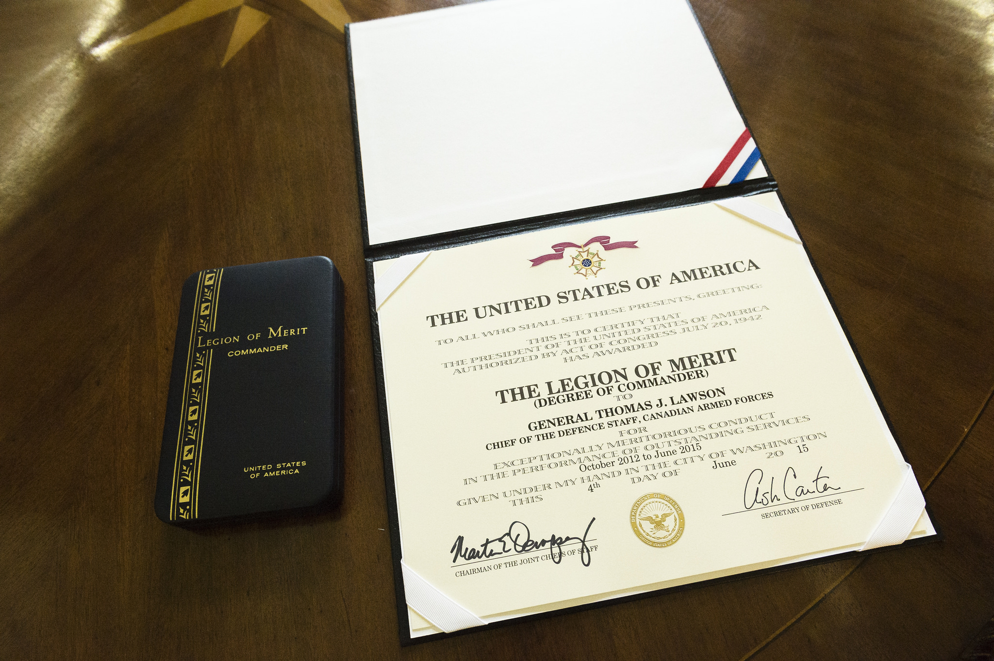 A Legion of Merit award lays on a table during a presentation for ...