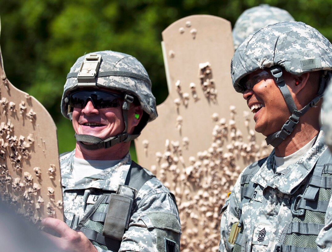 Army Sgts. Maj. Dennis Koski and Jan Javier share a laugh during range ...