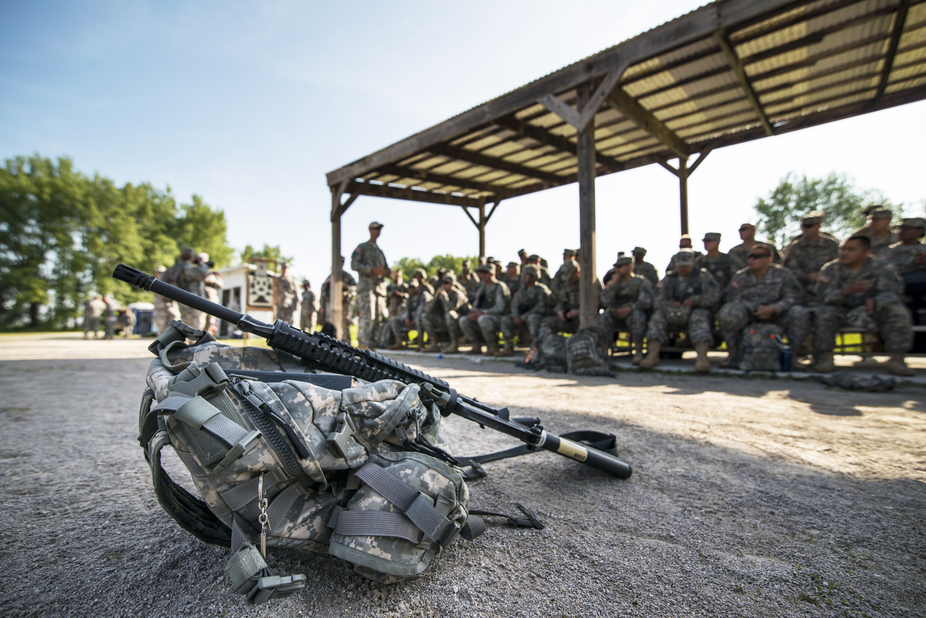 Army reserve soldiers listen as Master Sgt. Russell Moore conducts a ...