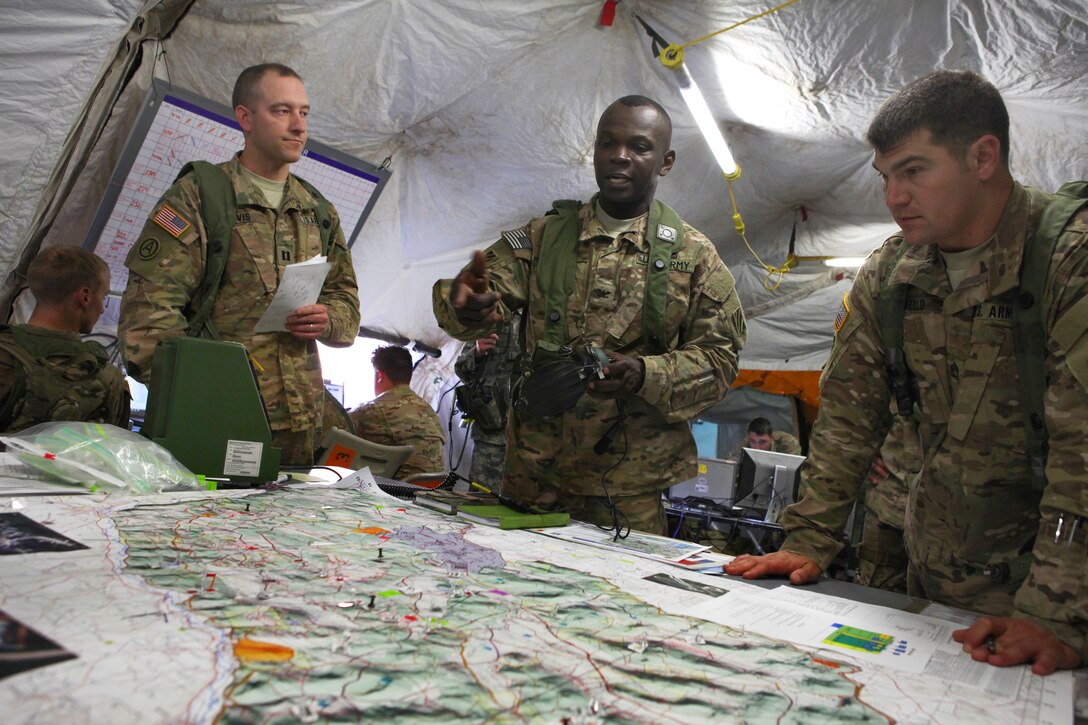 U.S. Army Col. Robert Ashe, center, conducts a battle update brief in ...