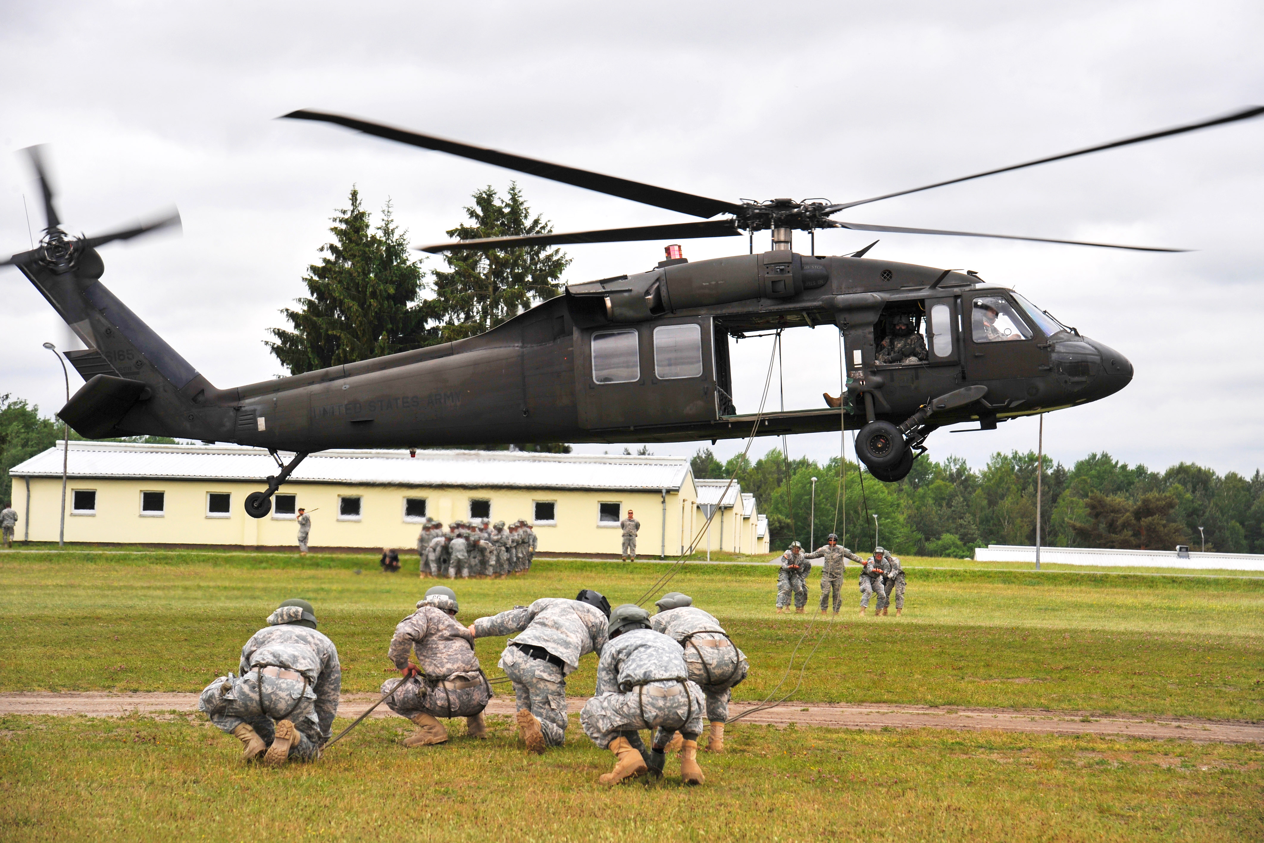 U.S. troops prepare to rappel from a UH-60 Black Hawk helicopter during ...
