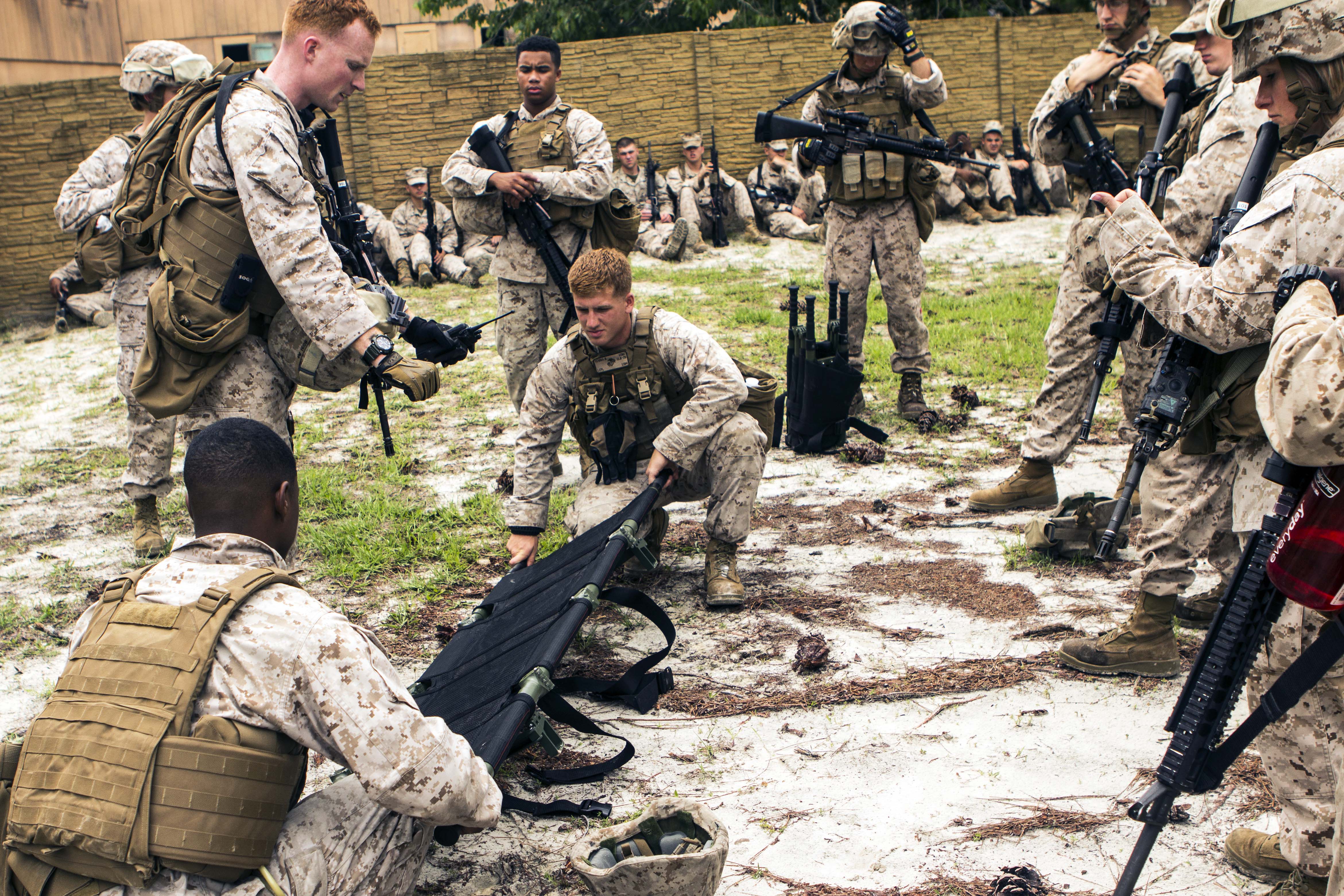 Marines and sailors ready a litter to carry a simulated casualty during ...