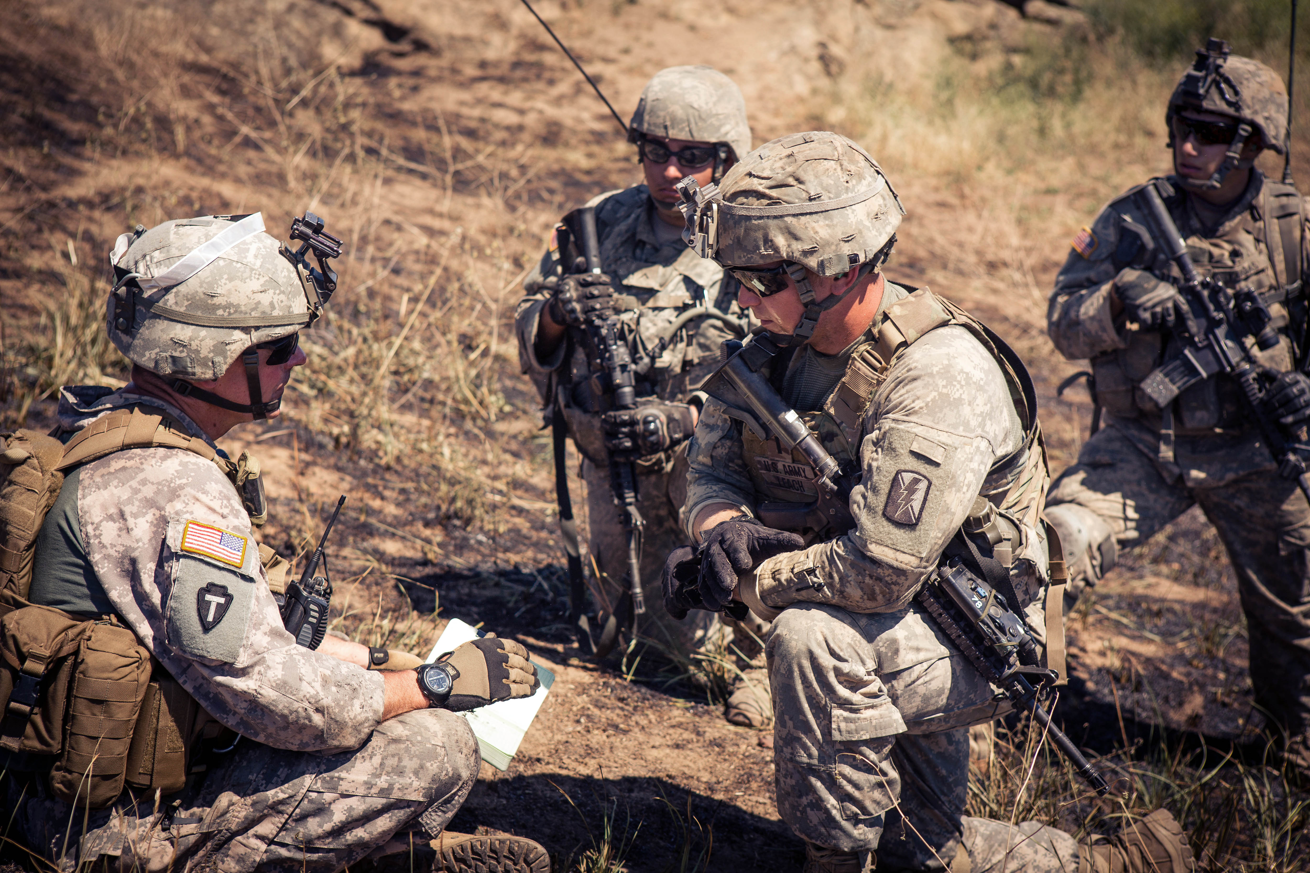 Army Maj. Chris Walter, left, mentors Army 1st Lt. Travis Leach during a deliberate attack live ...
