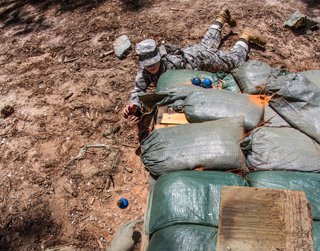 A soldier throwspractice grenades into a bunker at the hand grenade ...