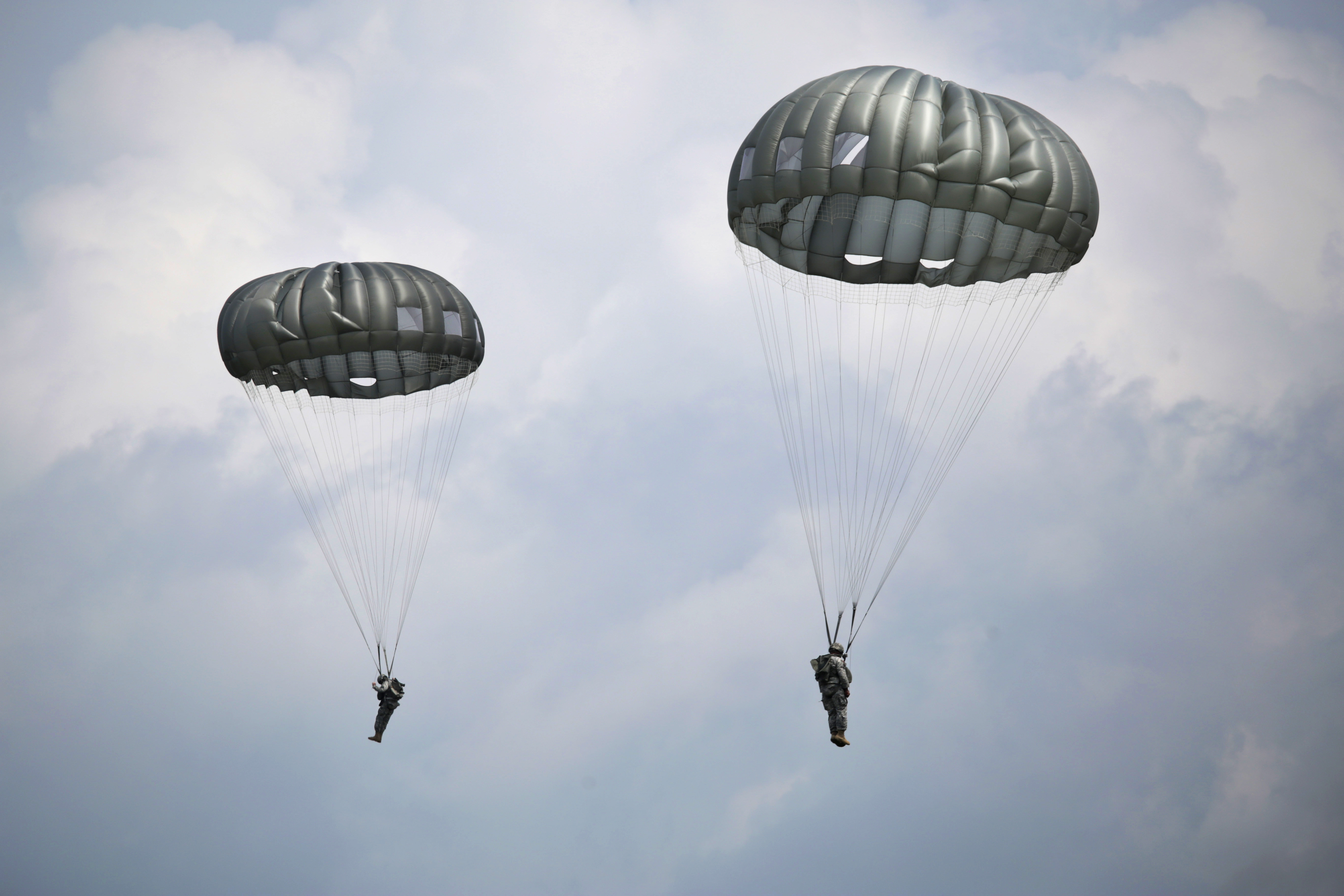 Army Reserve soldiers descend during an airborne jump over Scorpion ...