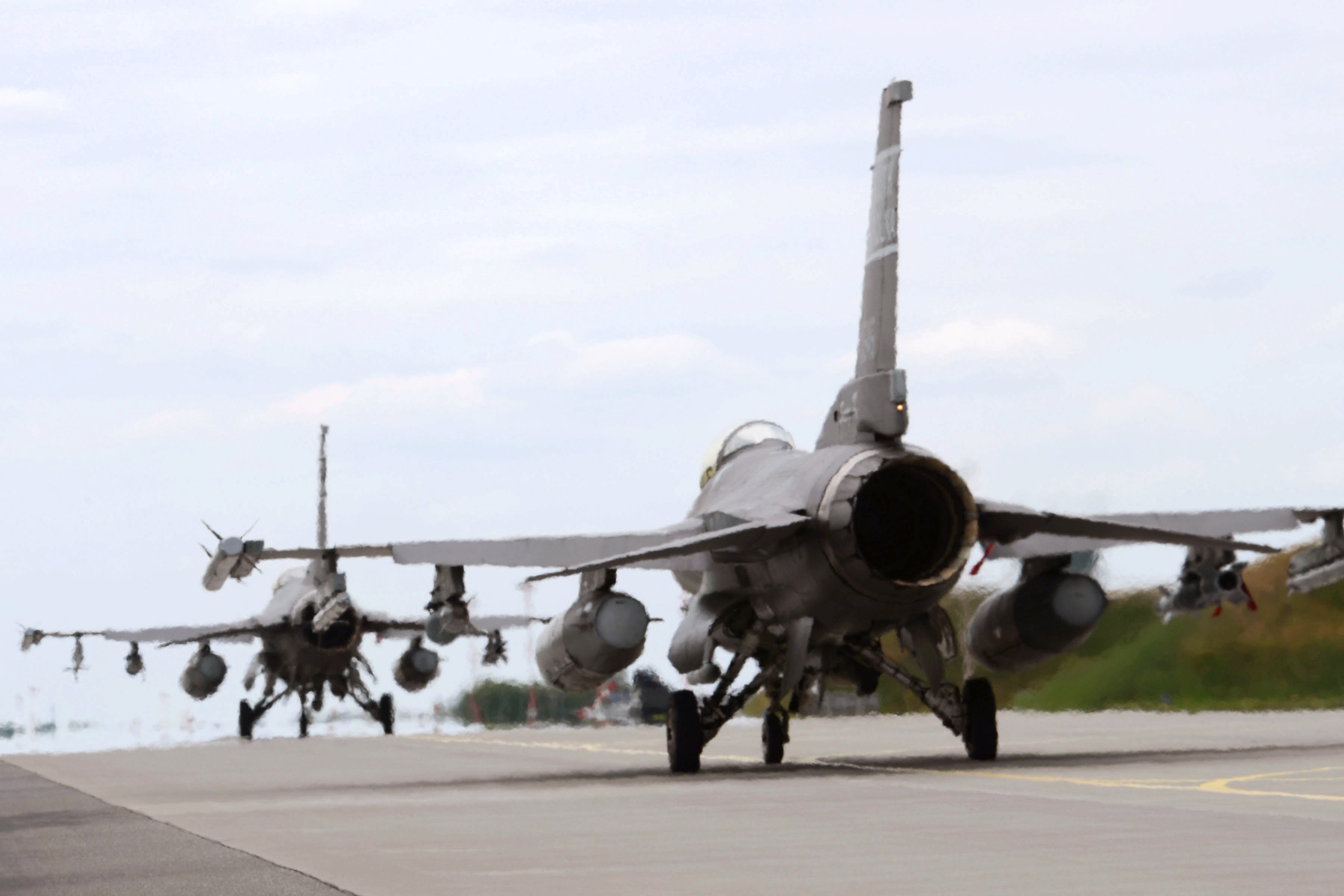 U.S. aircraft taxi on the runway on Lask Air Base, Poland, before ...