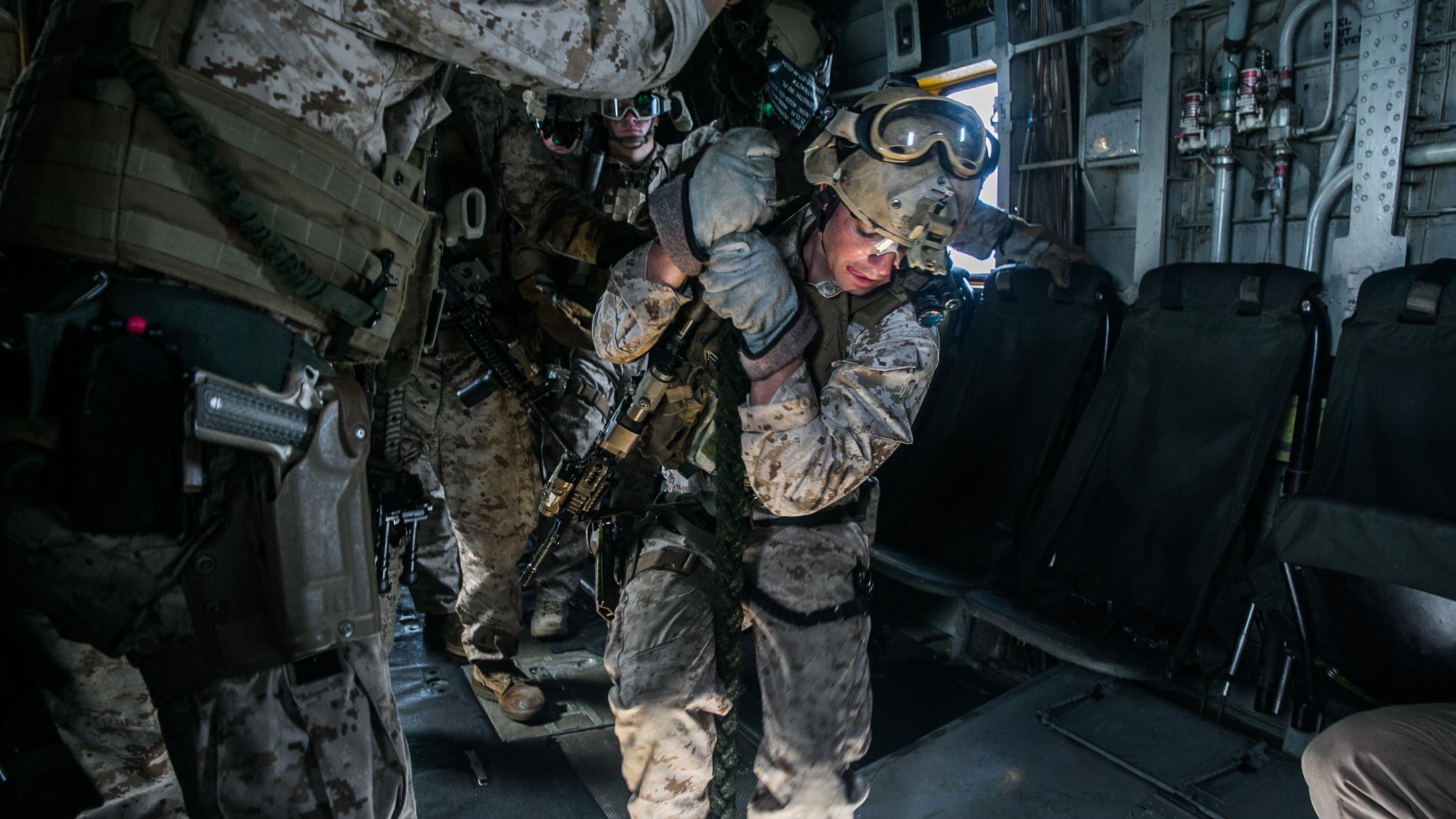 U.S. Marines fast rope from CH-53E Super Stallion at sea