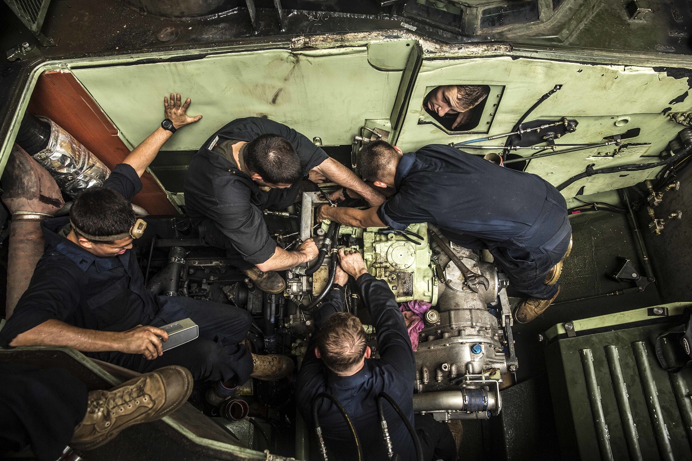 U.S. Marines conduct maintenance on tracks