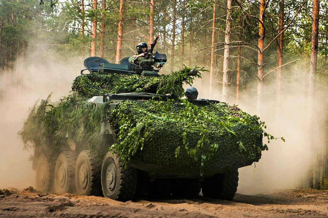 Lithuanian and Portuguese soldiers in their tactical fighting vehicle ...