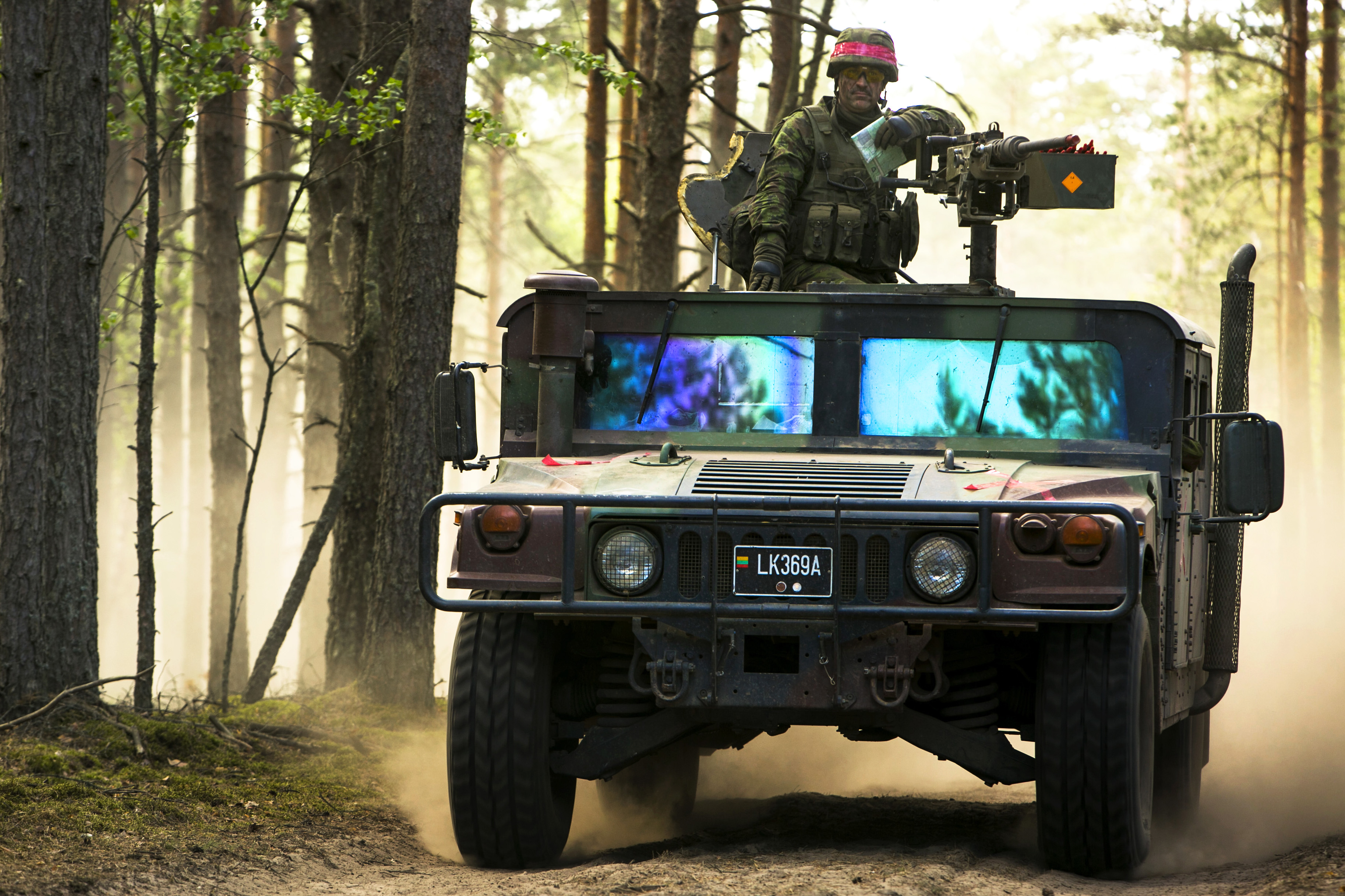 Lithuanian soldiers ride in their humvee toward their next objective ...