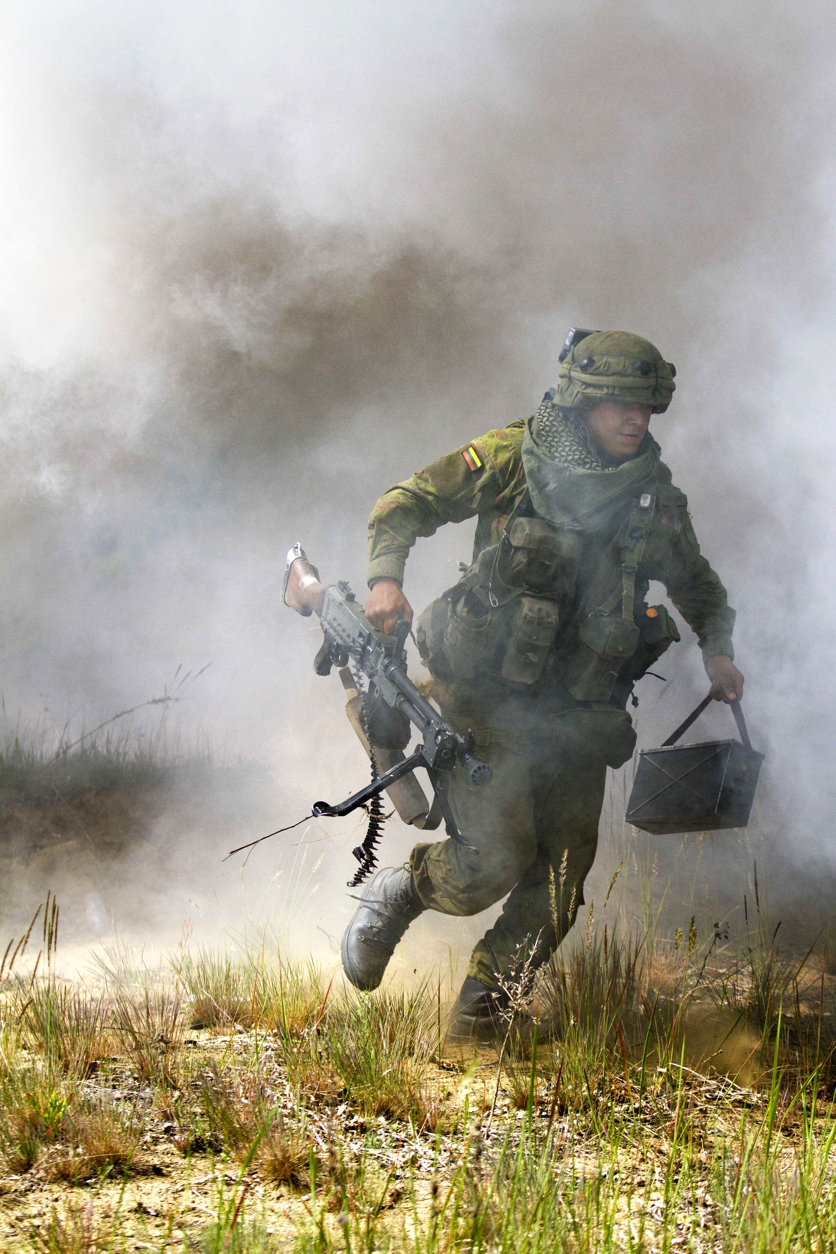 A Lithuanian Land Forces soldier advances toward his next objective ...