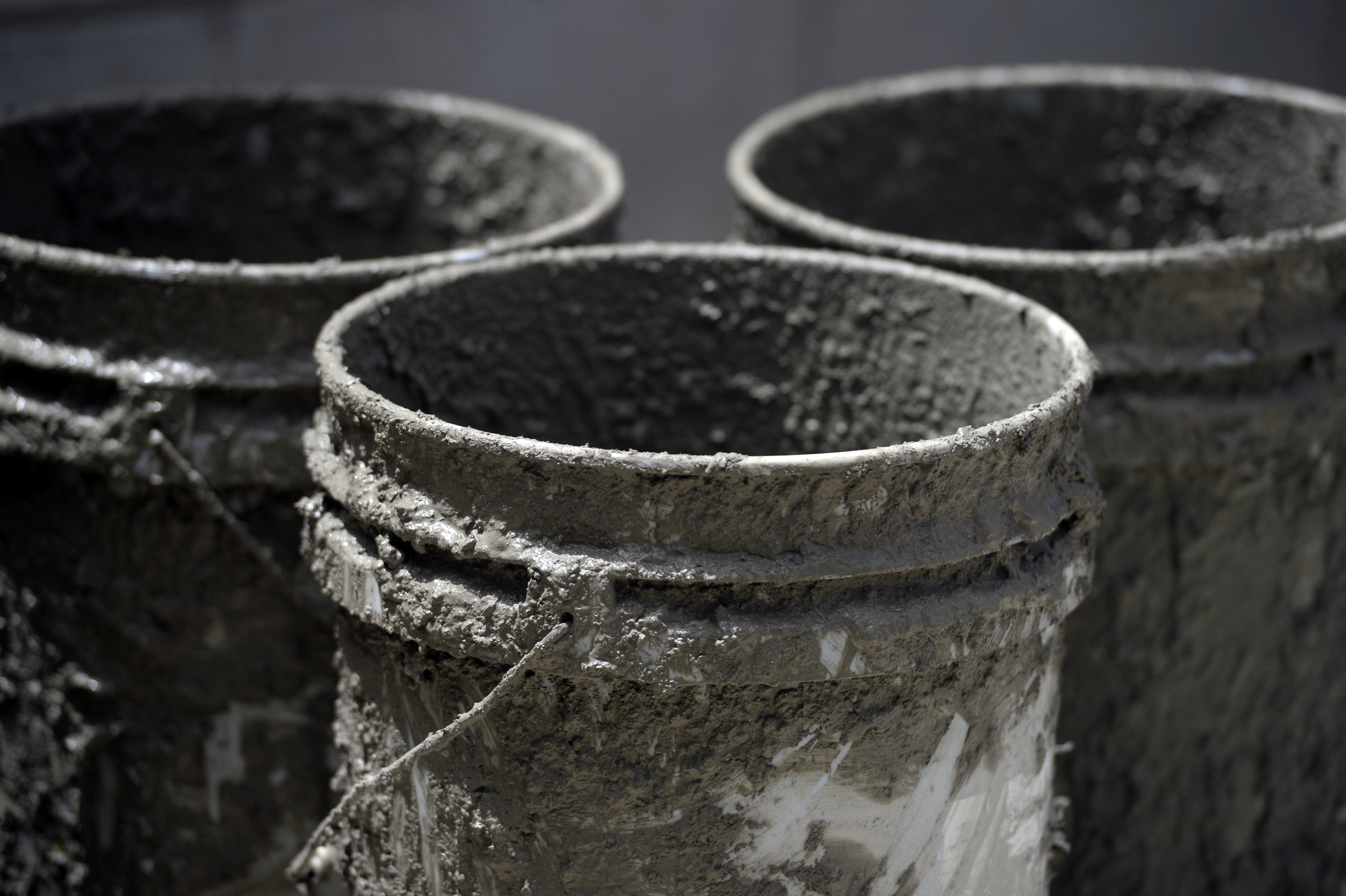 Buckets stand after they transported cement to create the bond beam for ...