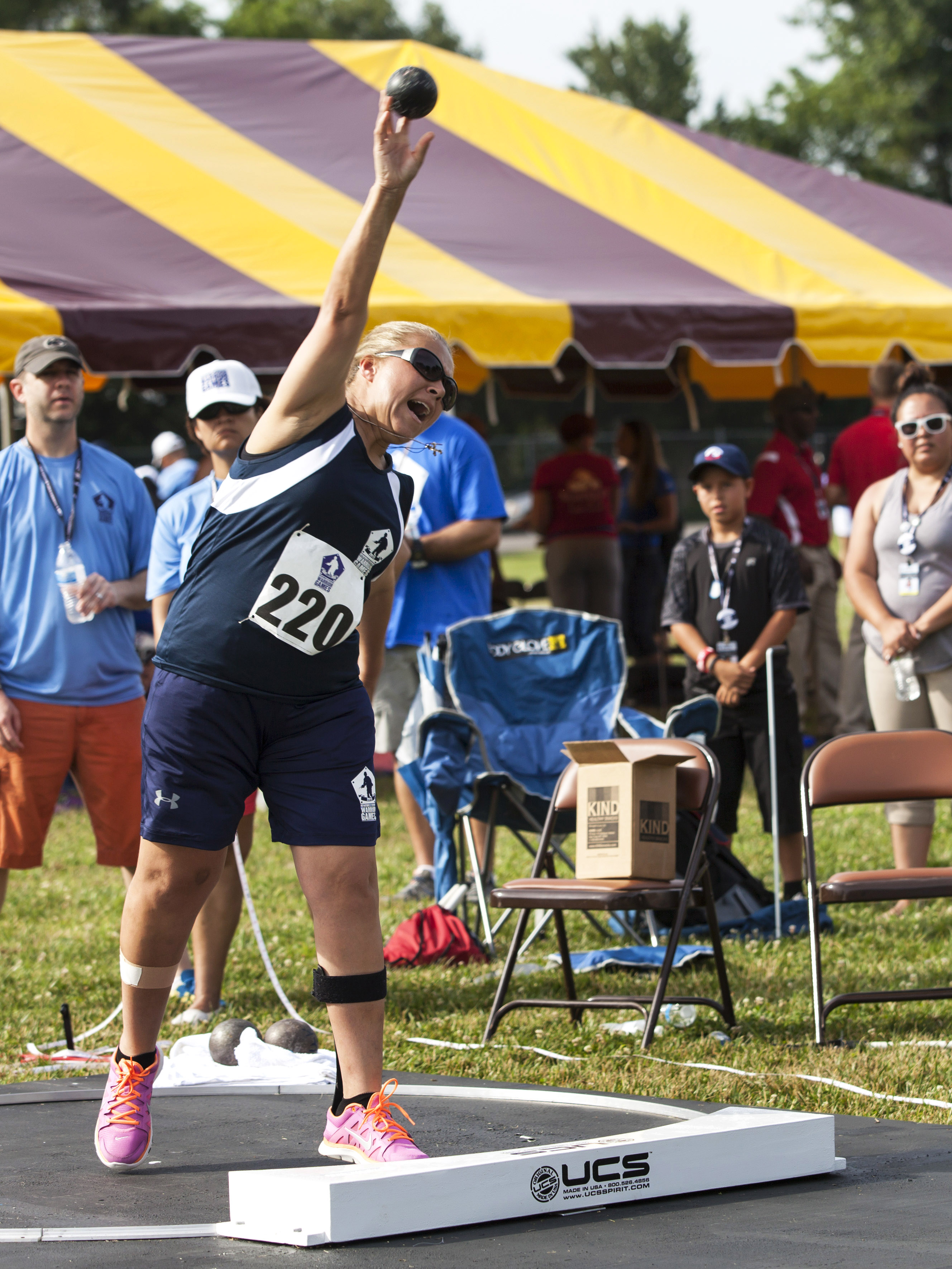 U.S. Navy Chief Petty Officer Leticia Baugher throws the shot put ...
