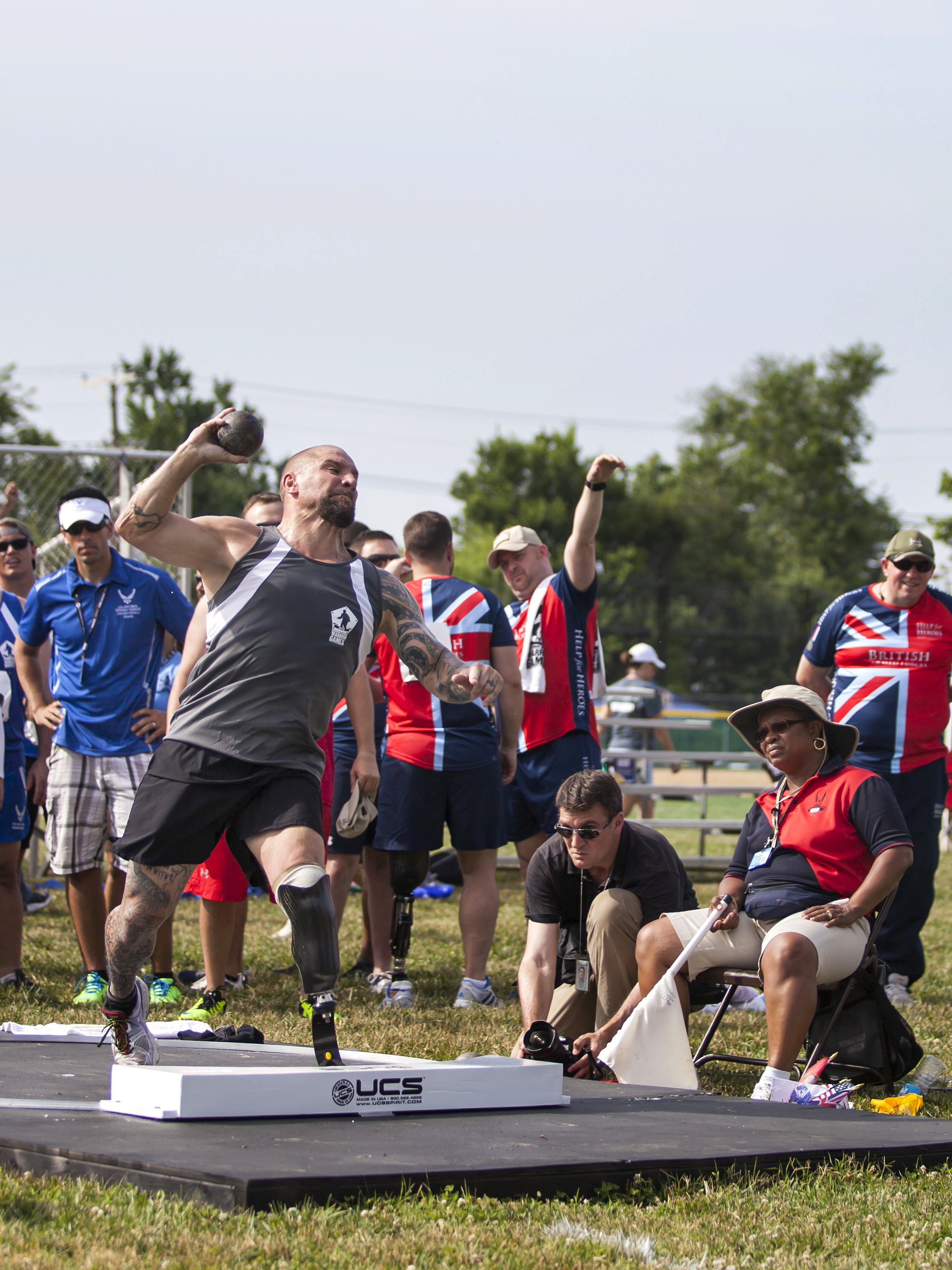 U.S. Navy Petty Officer 1st Class Steven Toboz throws the shot put ...