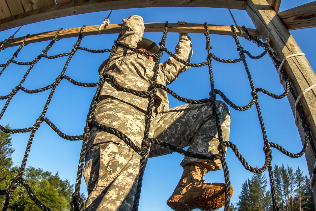 Army Reserve Sgt. 1st Class Lourdes Navarro demonstrates how to climb a ...