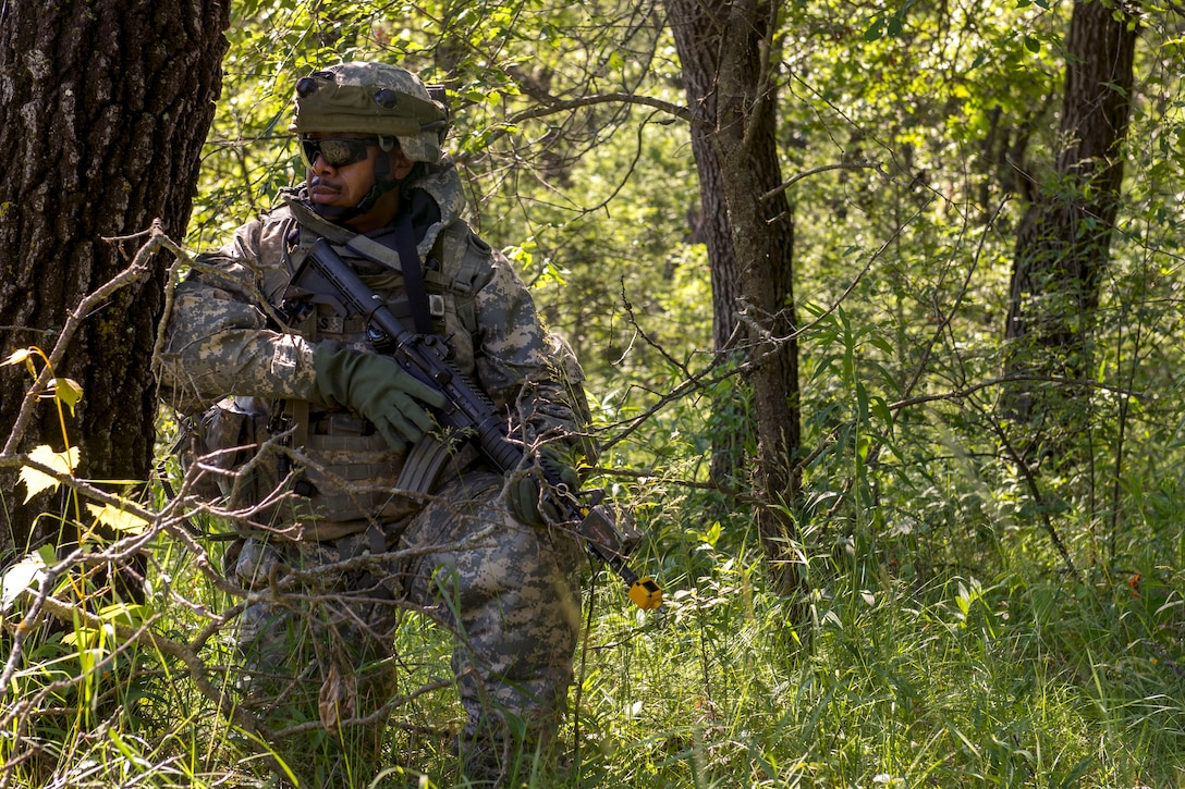 Army Master Sgt. Antonio Rawls provides security during a convoy ...