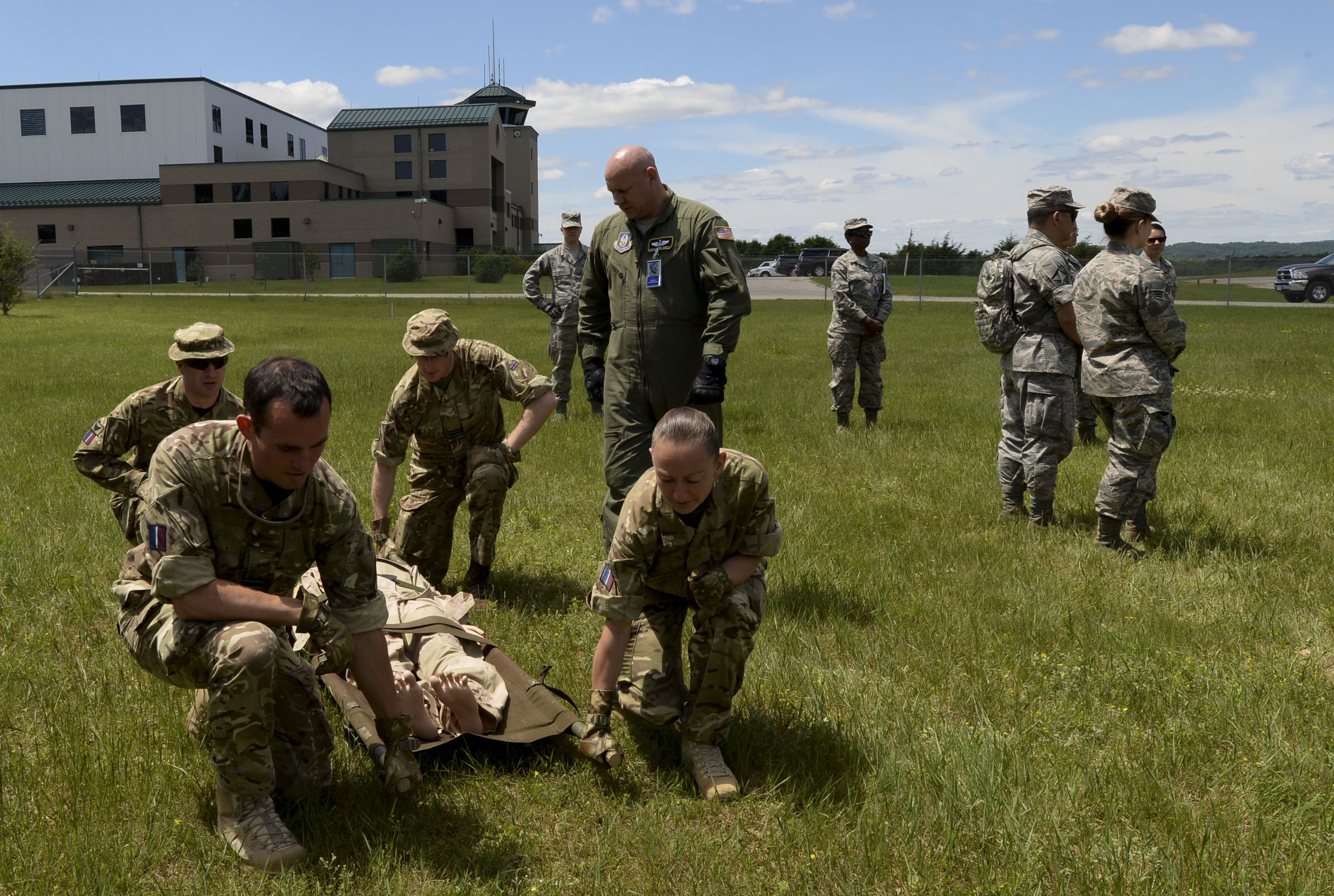 U.S. and British servicemembers carry a gurney during medical ...