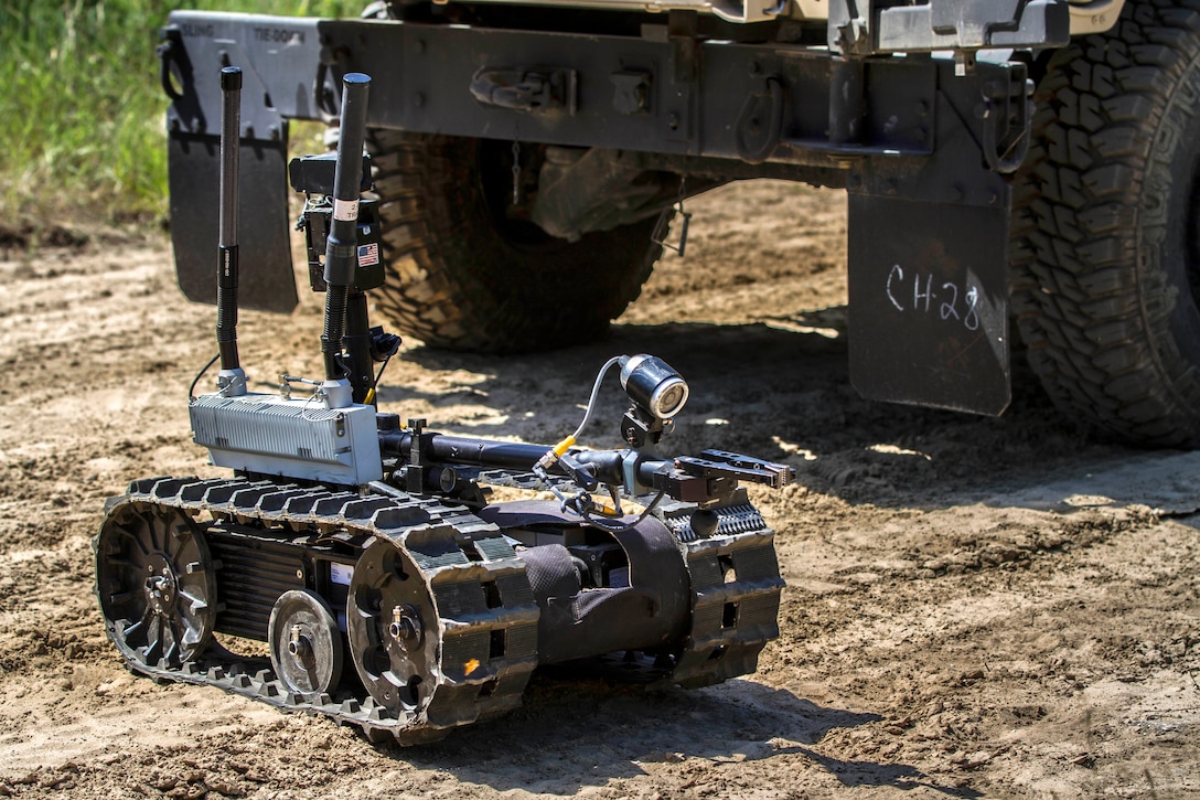 Army Reserve Sgt. Santiago Zapata, not shown, uses a ground remote to ...