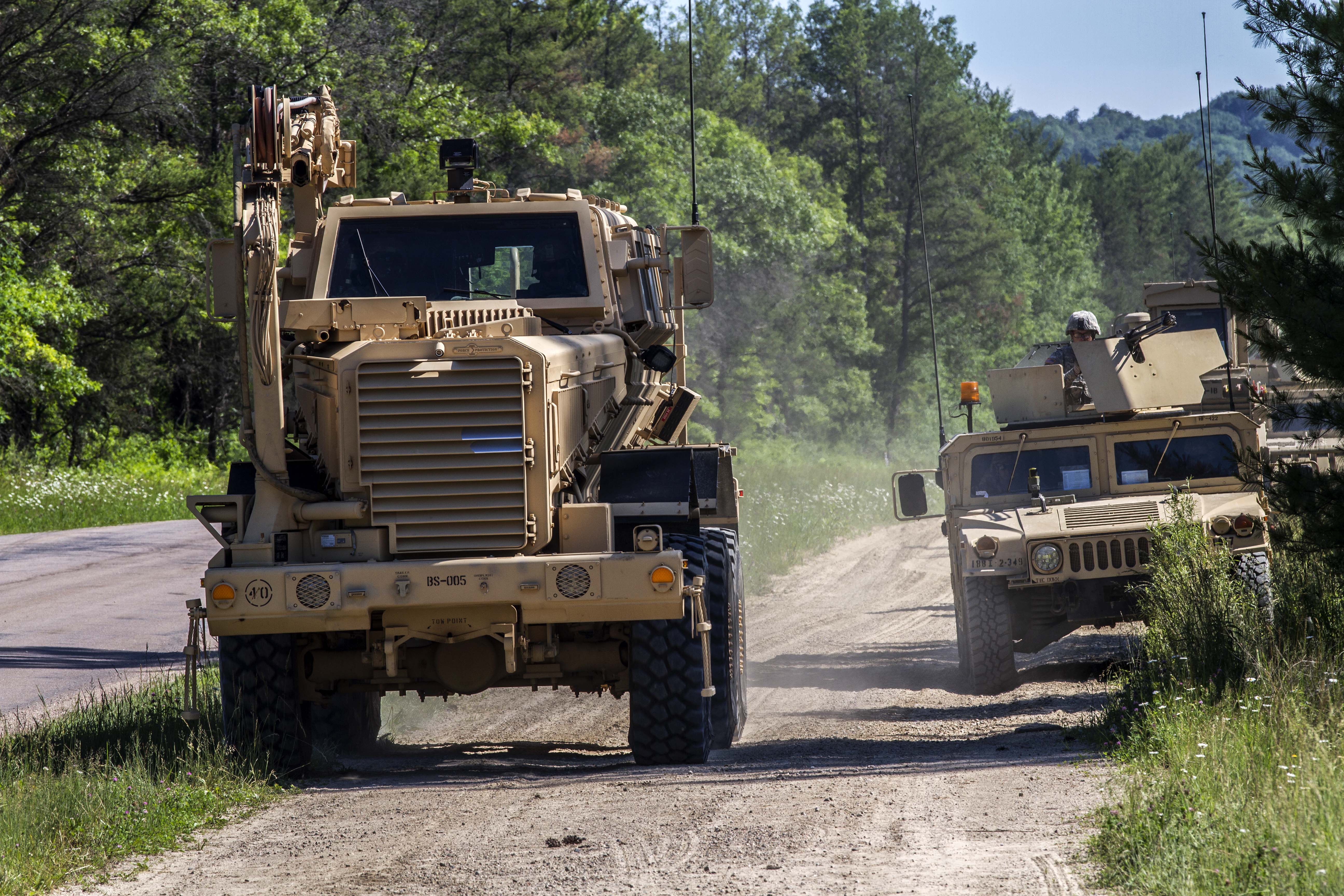 A Buffalo mine-resistant, ambush-protected vehicle moves ahead to check ...