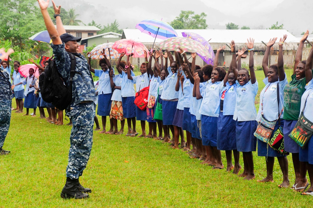 USNS Mercy Command Master Chief Dedrick Walker plays a game with local ...