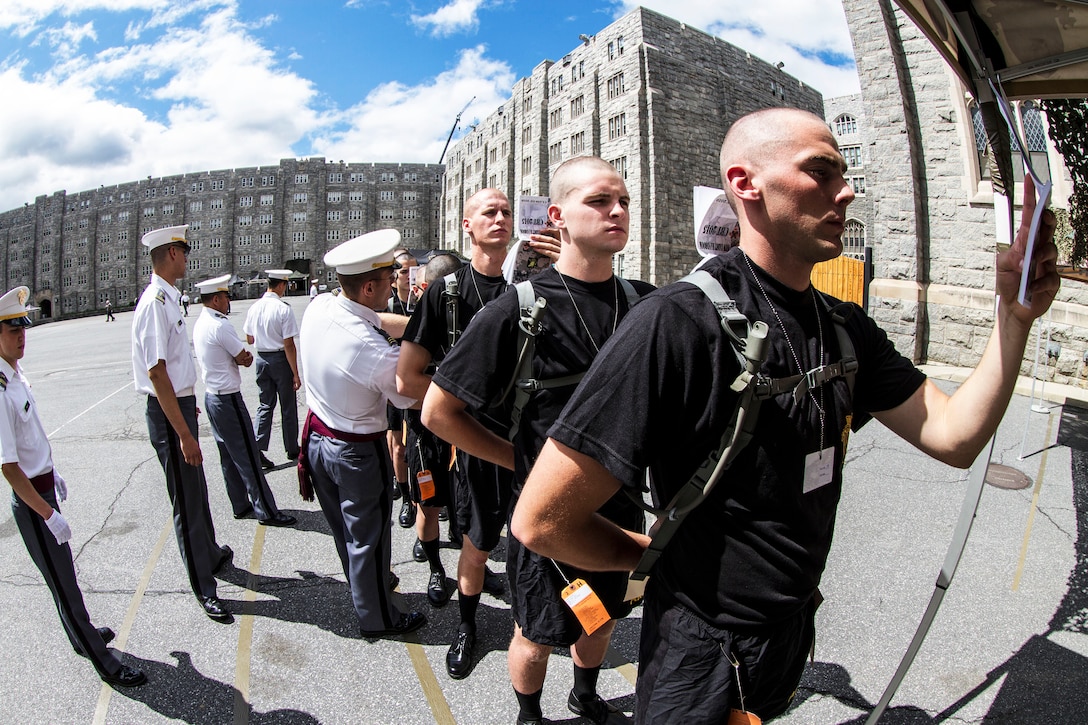 A squad of future Cadets read their future cadet handbooks while ...